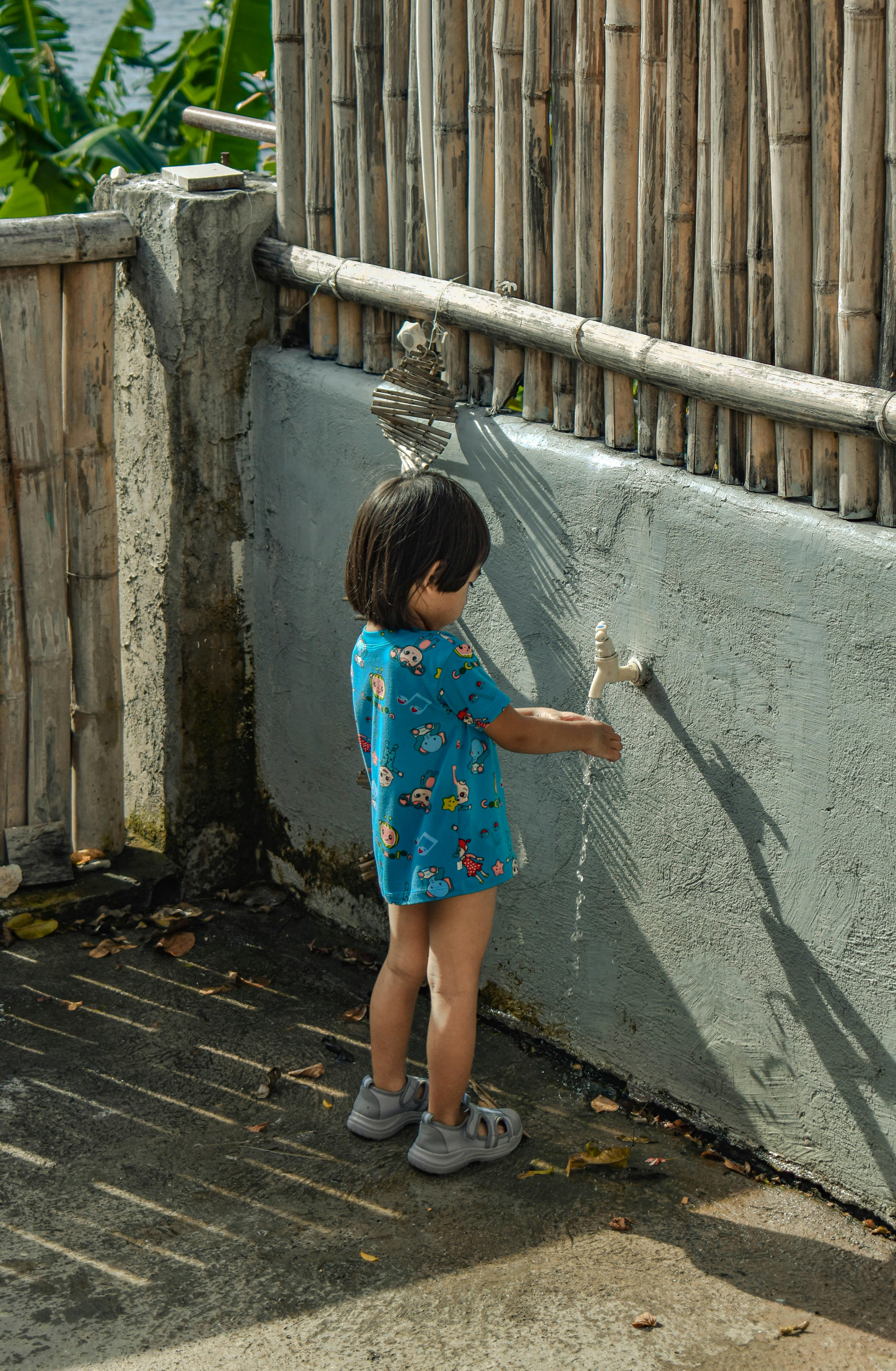 A Child by a Water Tap · Free Stock Photo