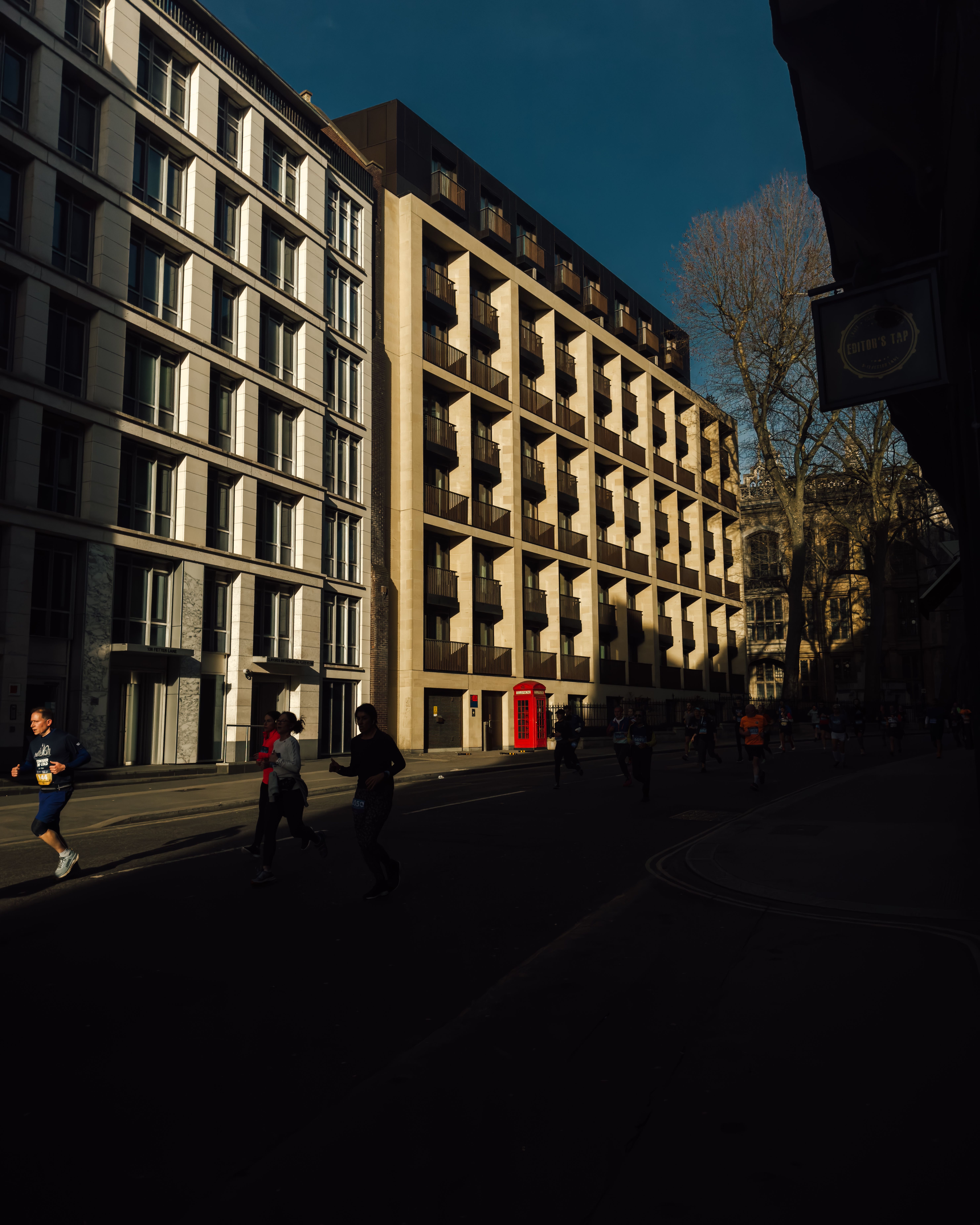 People Running in Shadow on Street · Free Stock Photo