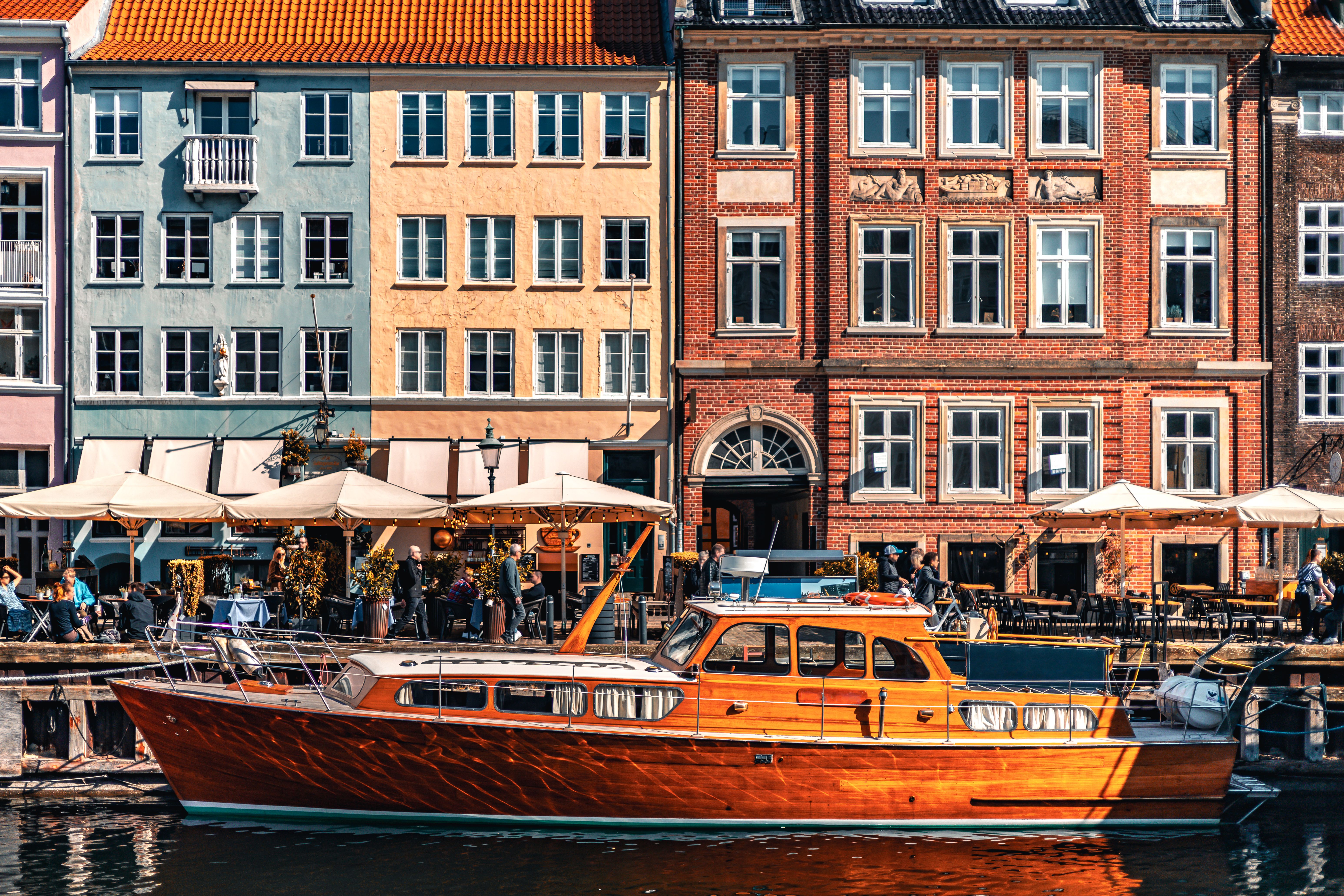 A boat is docked in front of colorful buildings · Free Stock Photo