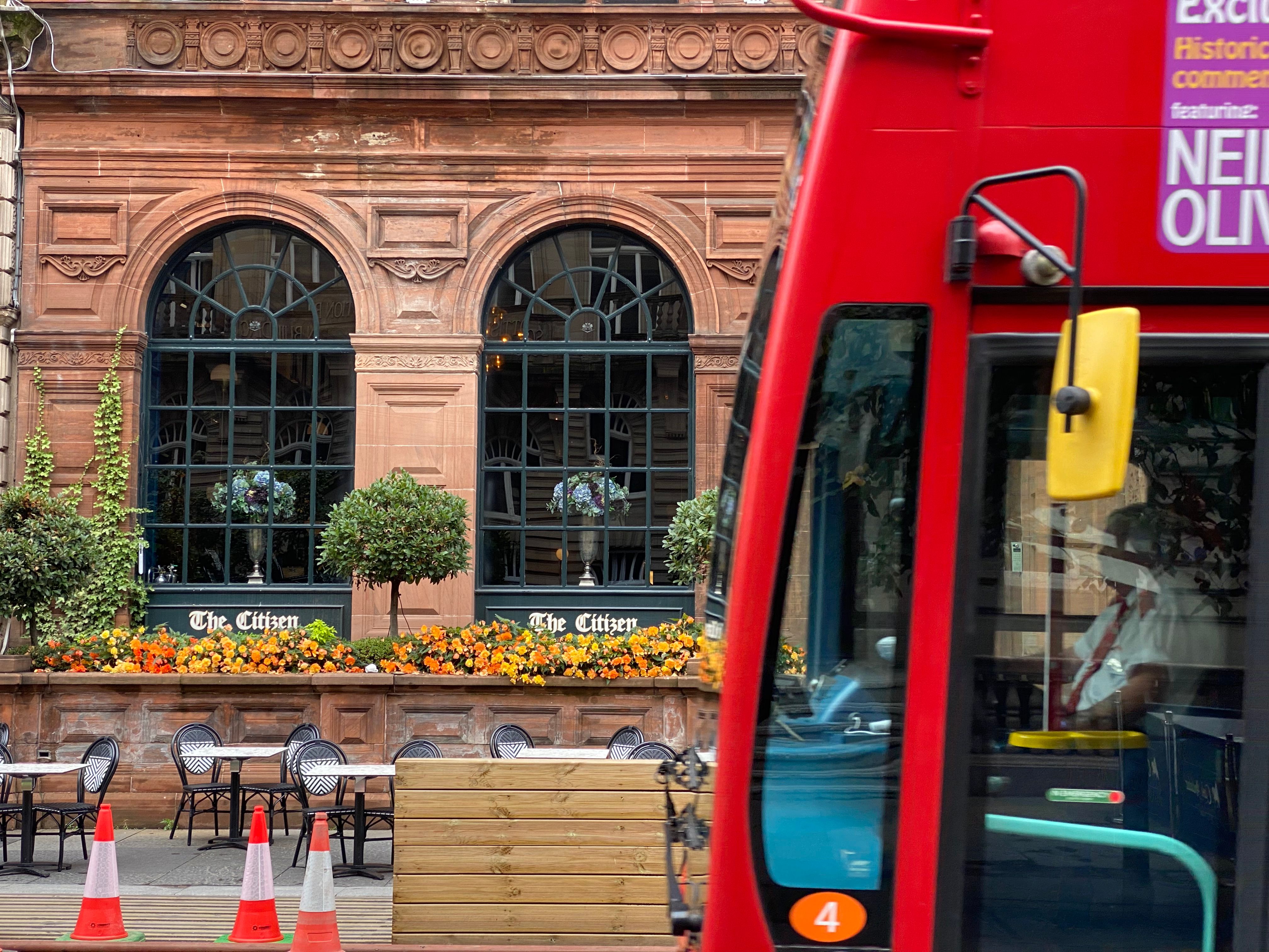 View of a Red Bus and the Exterior of a Building at 24 St Vincent Place ...