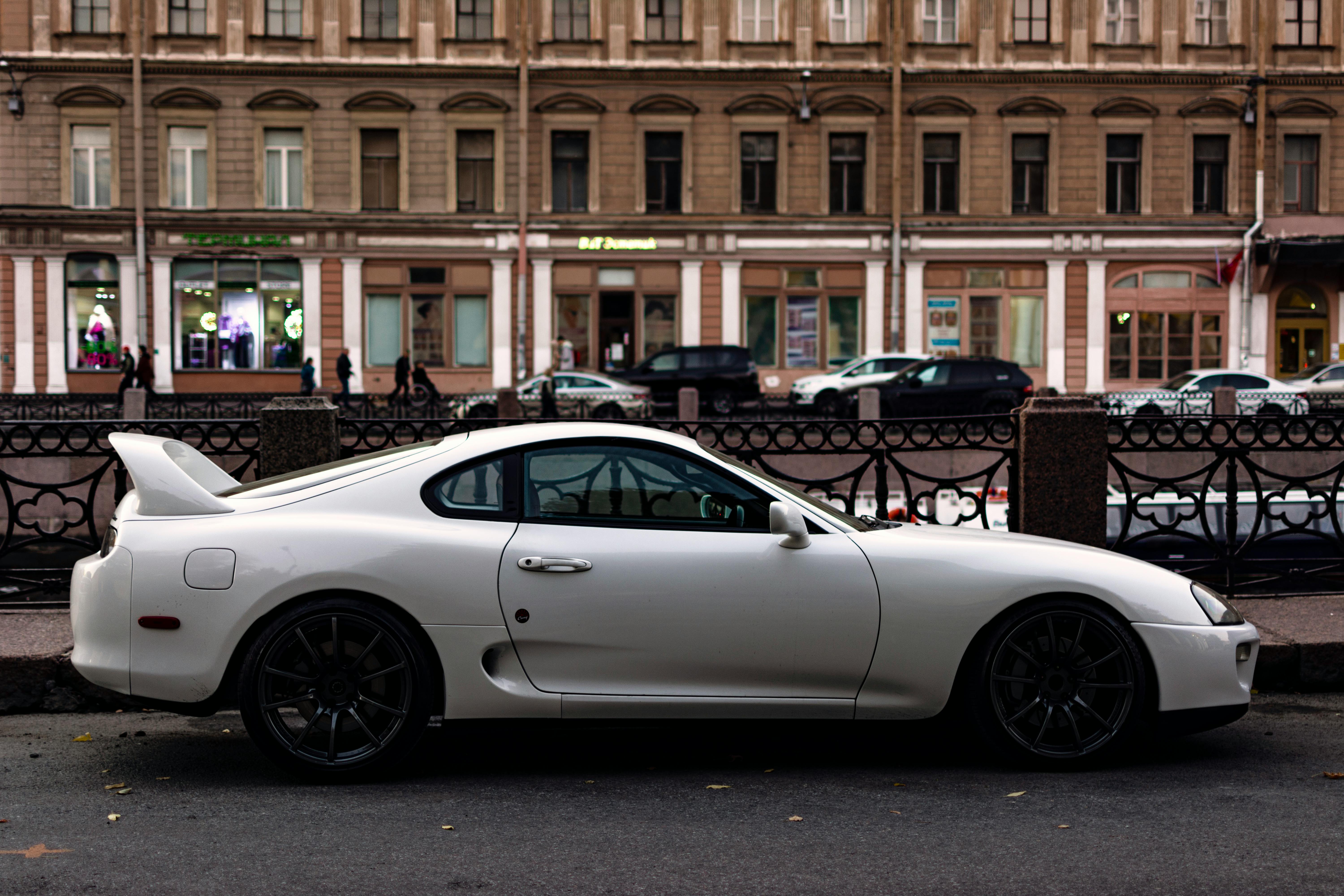 A White Toyota Supra Parked on the Street in City · Free Stock Photo