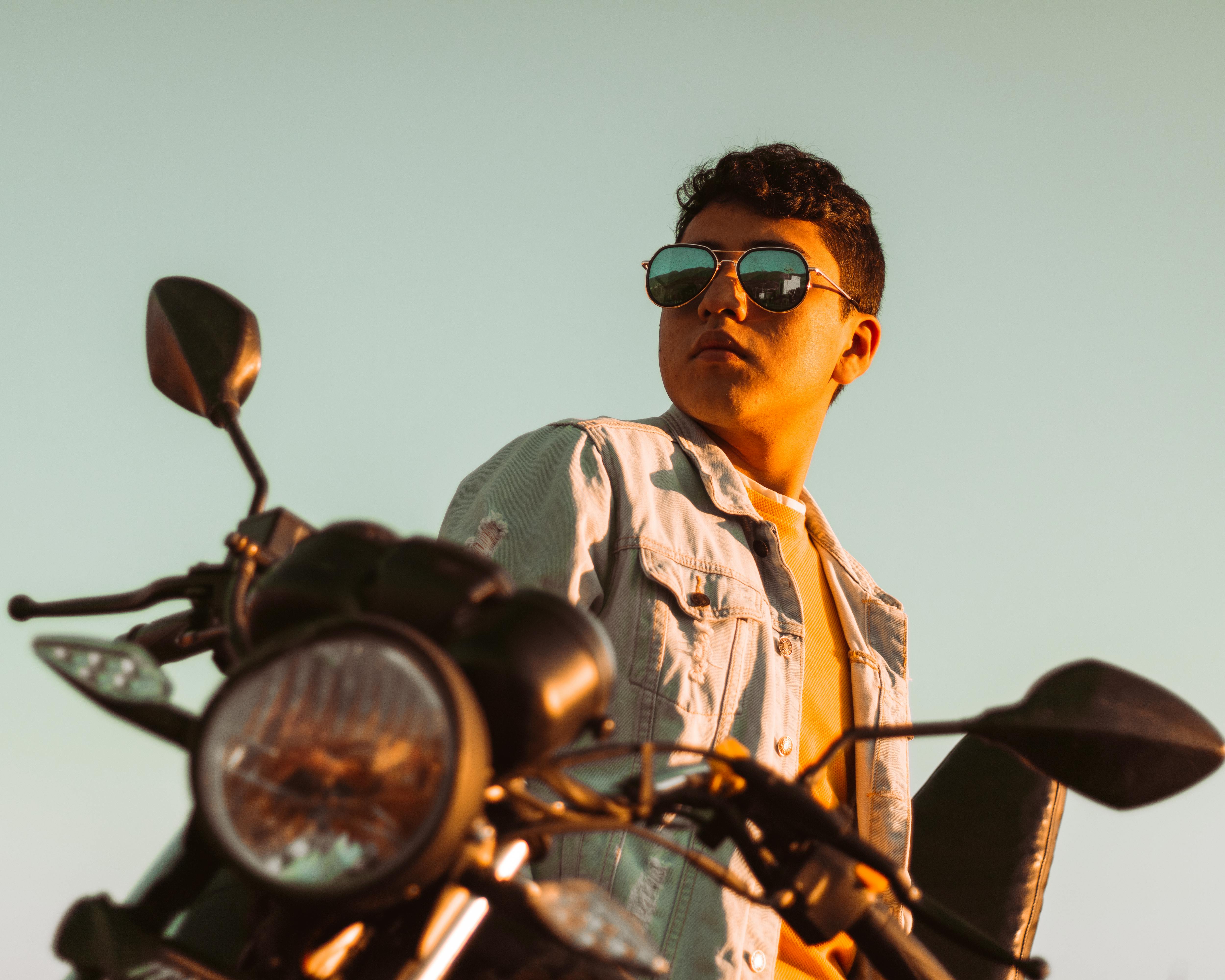 Young Man Pushing a Motorbike · Free Stock Photo