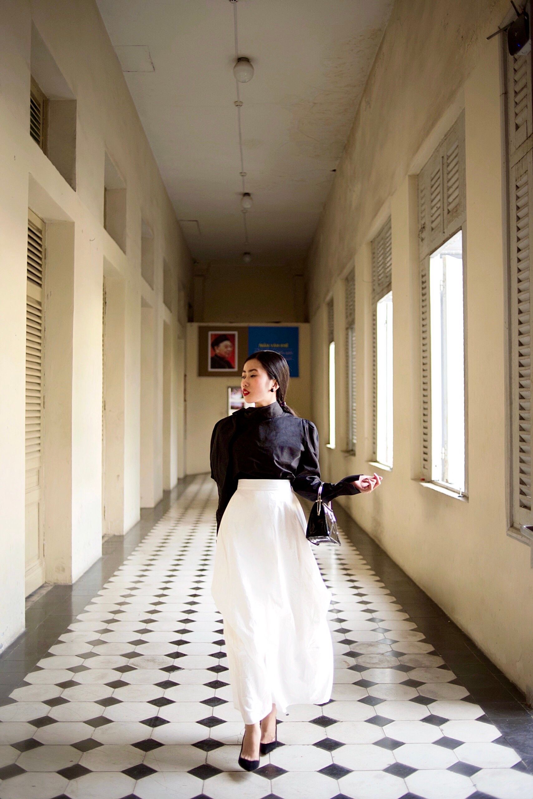 A Woman Standing in a Corridor · Free Stock Photo