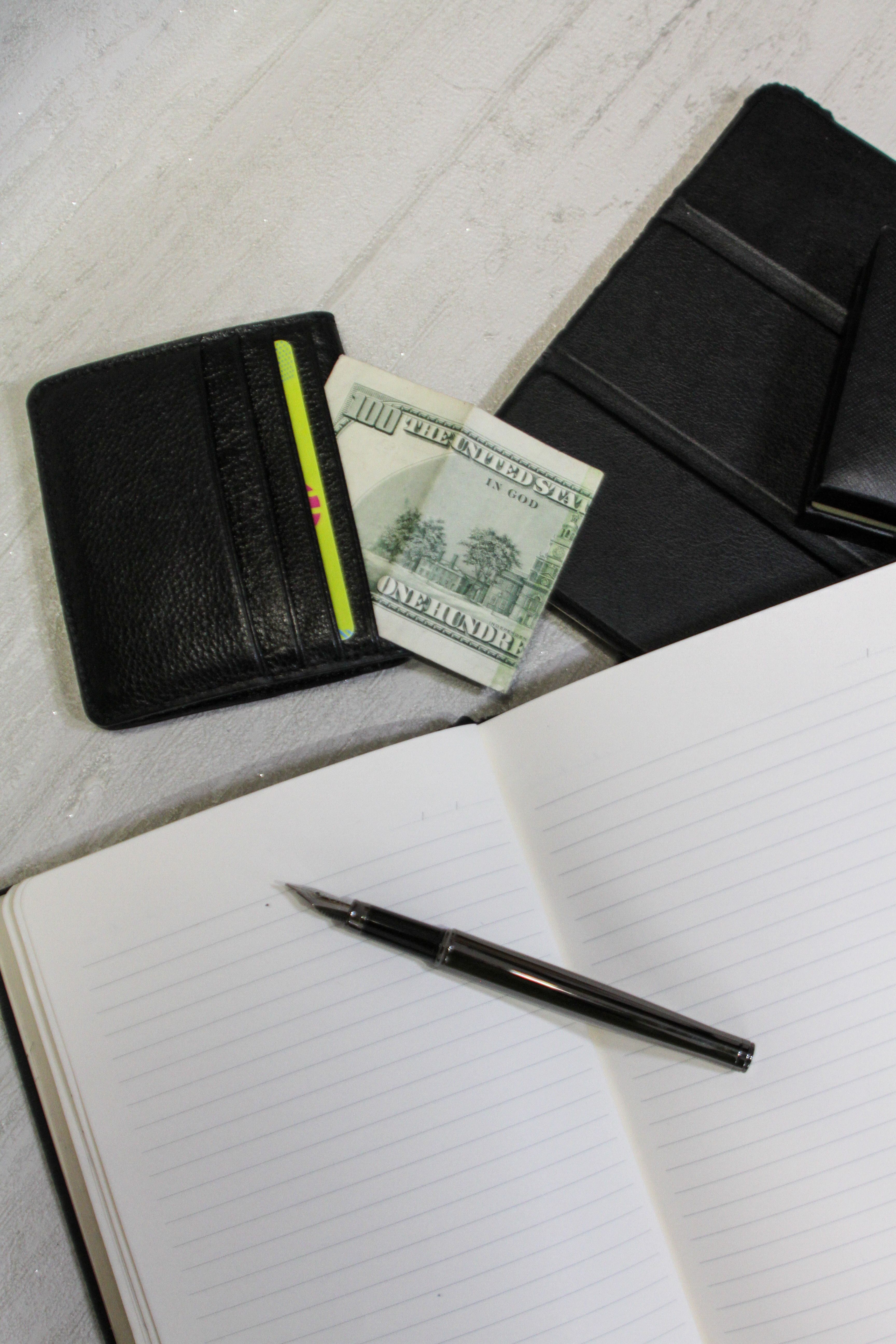 Close up of a Notebook and a Wallet · Free Stock Photo