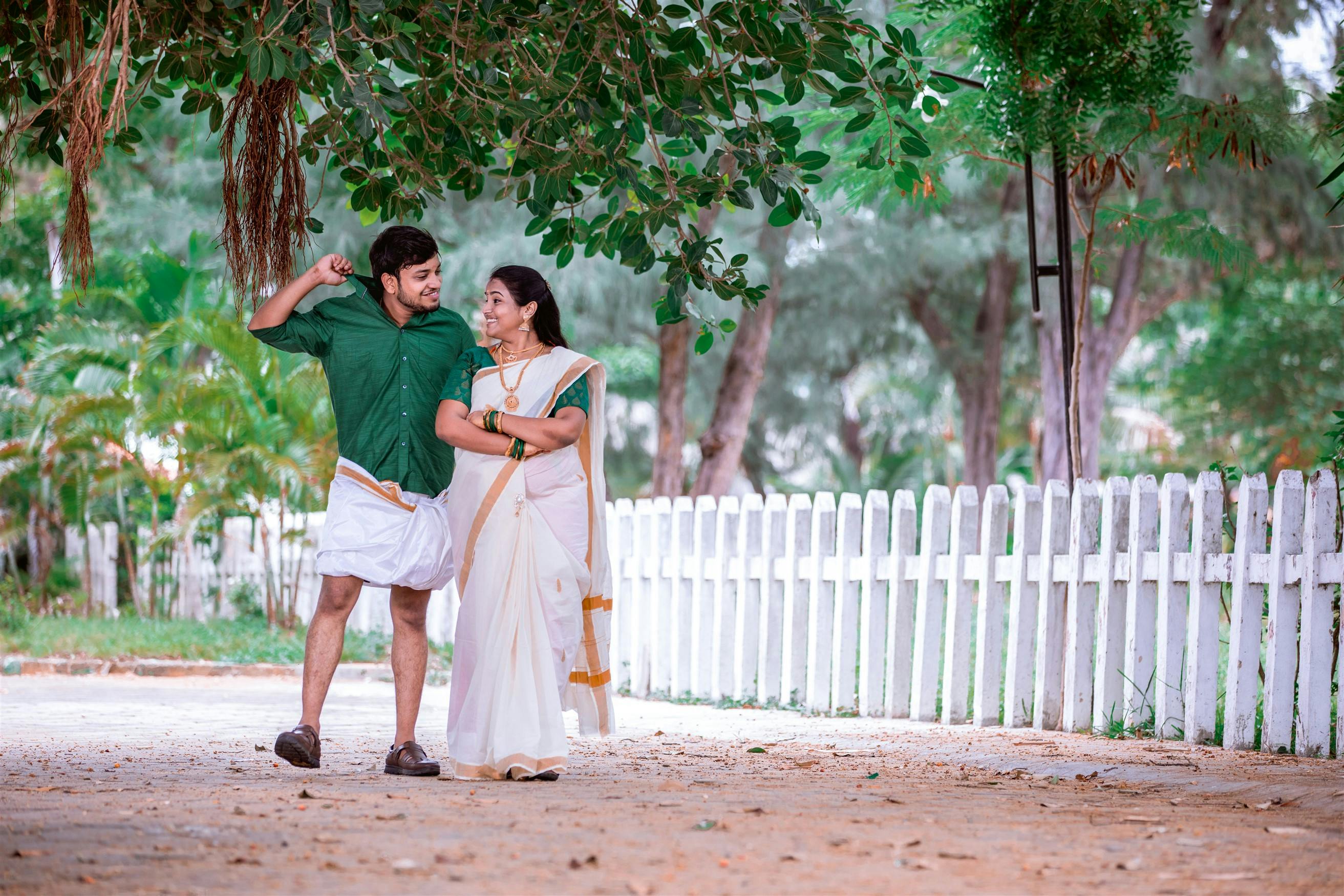 Man and Woman in Traditional Clothes Standing in a Park · Free Stock Photo
