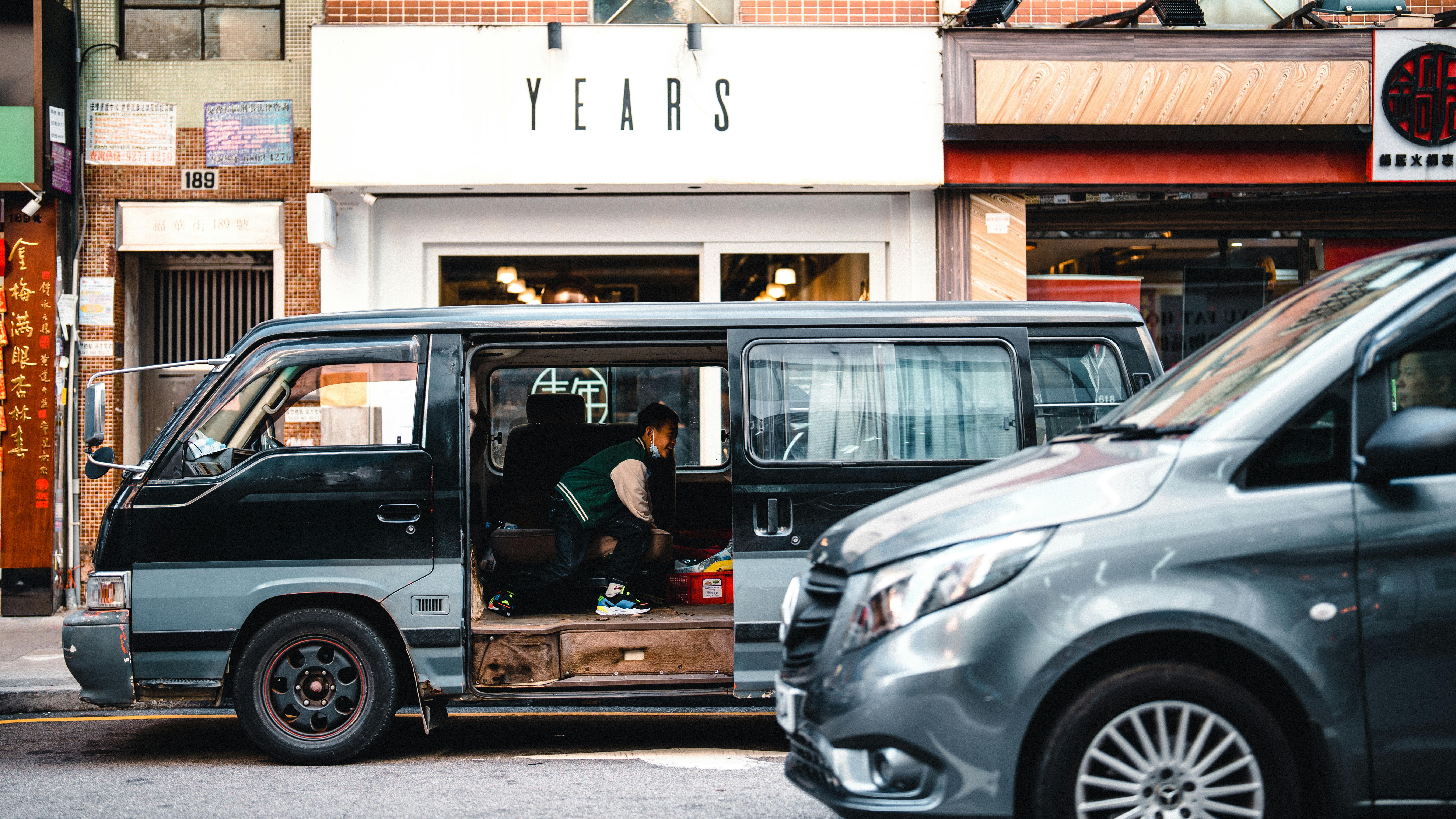 Laughing Boy in the Mini Van Parked on the Street · Free Stock Photo