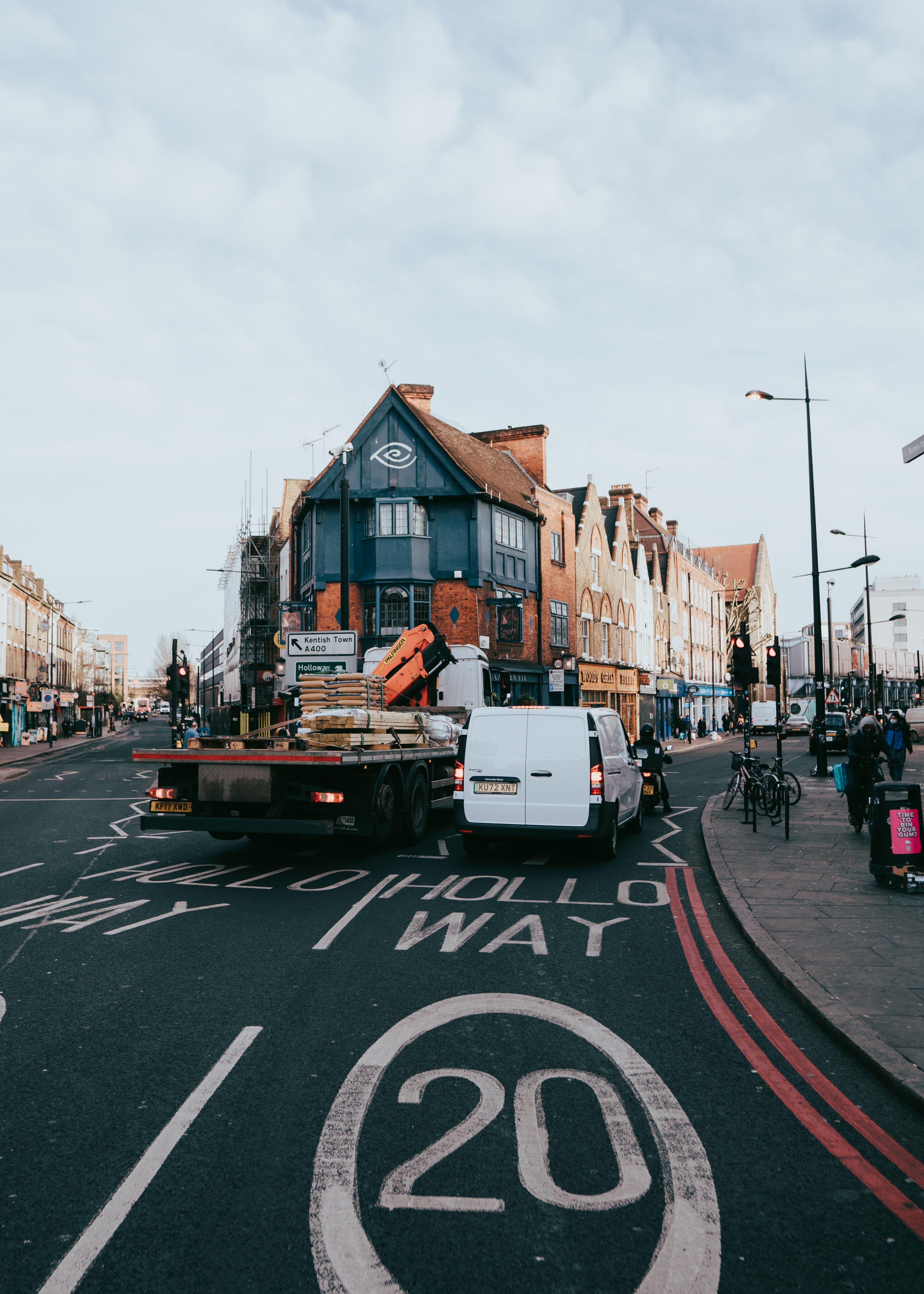 Cars on Road Near Concrete Building · Free Stock Photo