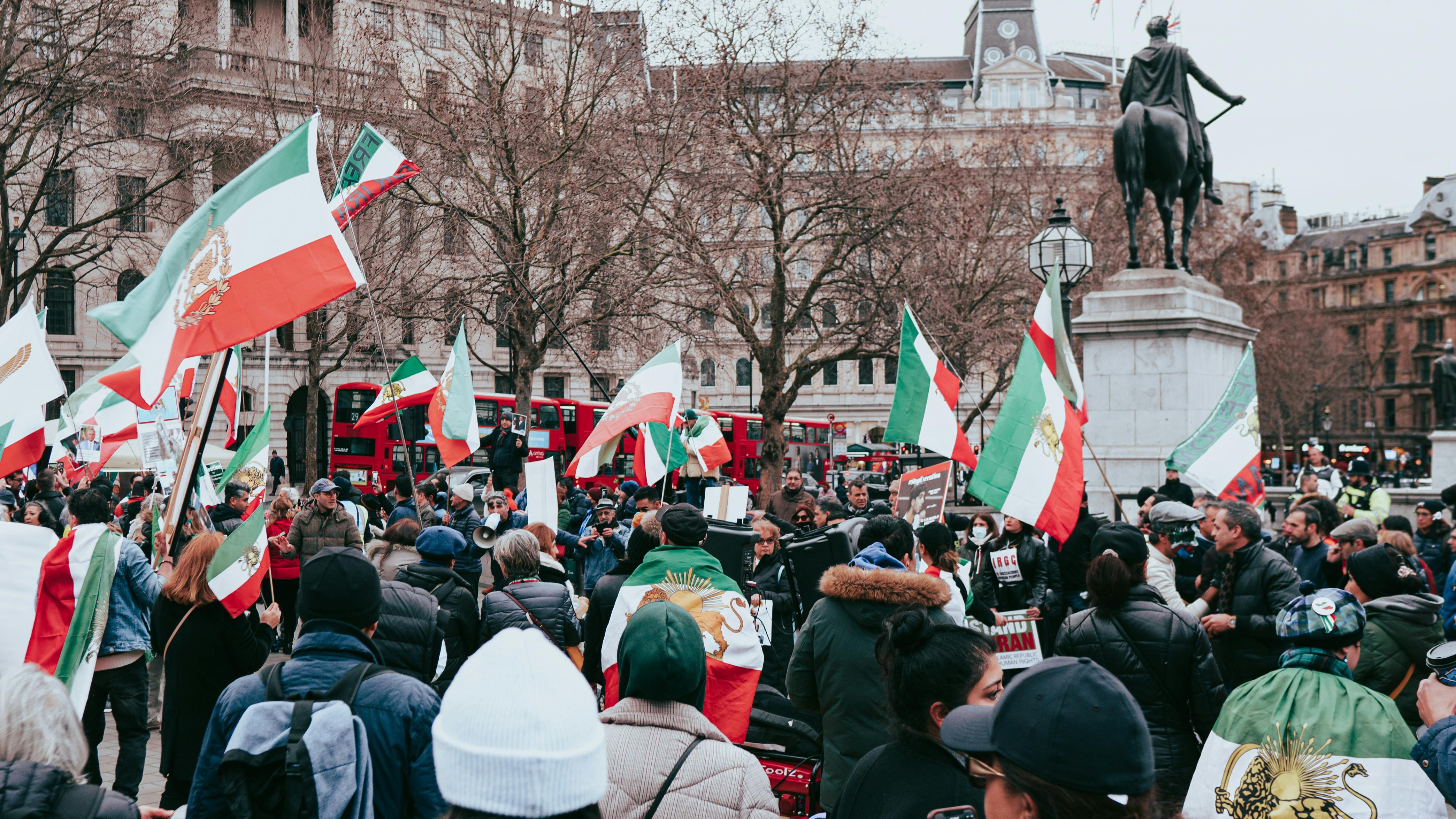 View of a Crowd Holding Flags, Protesting on a Street in City · Free ...