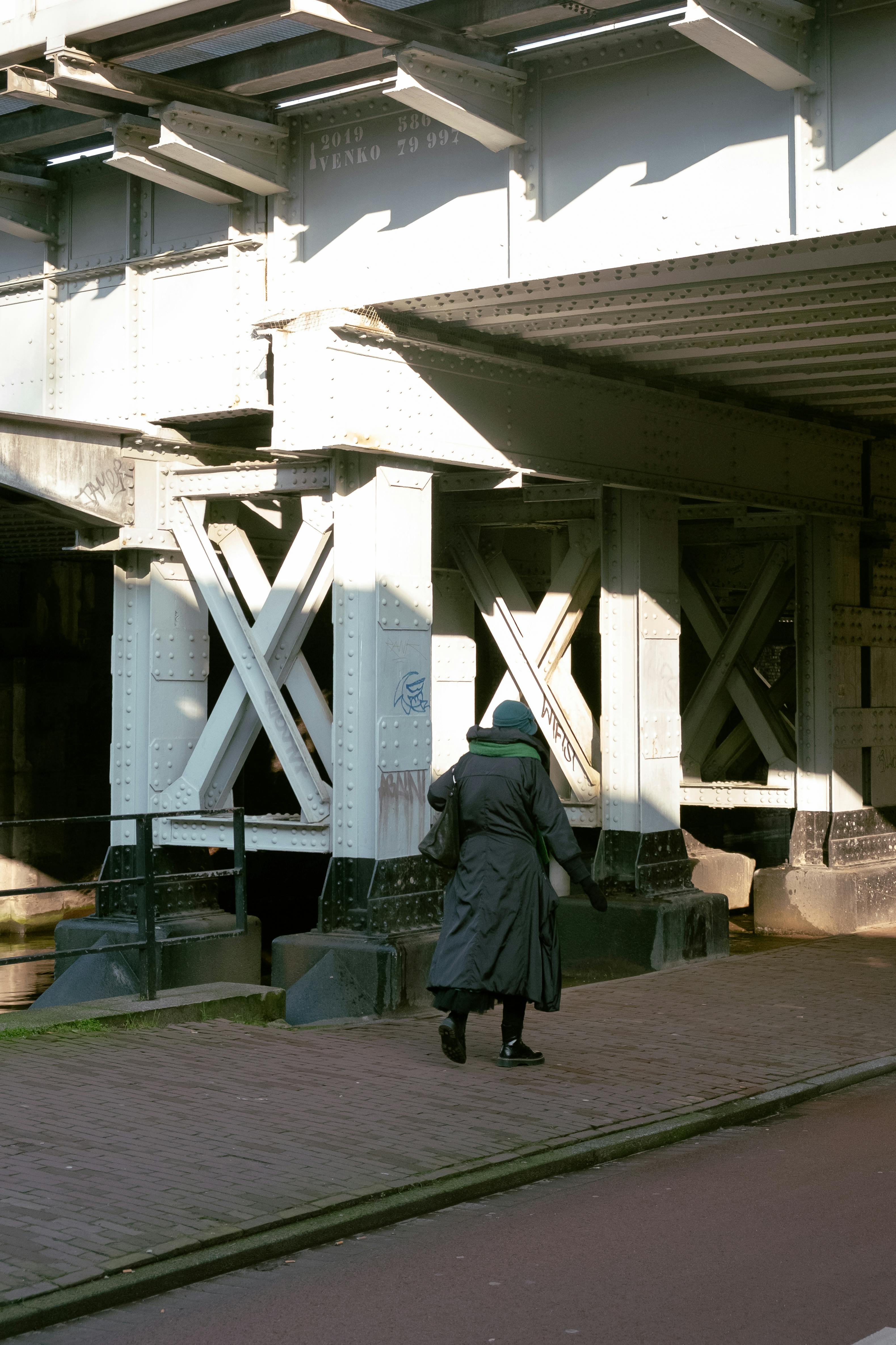 Woman Walking under the Bridge · Free Stock Photo