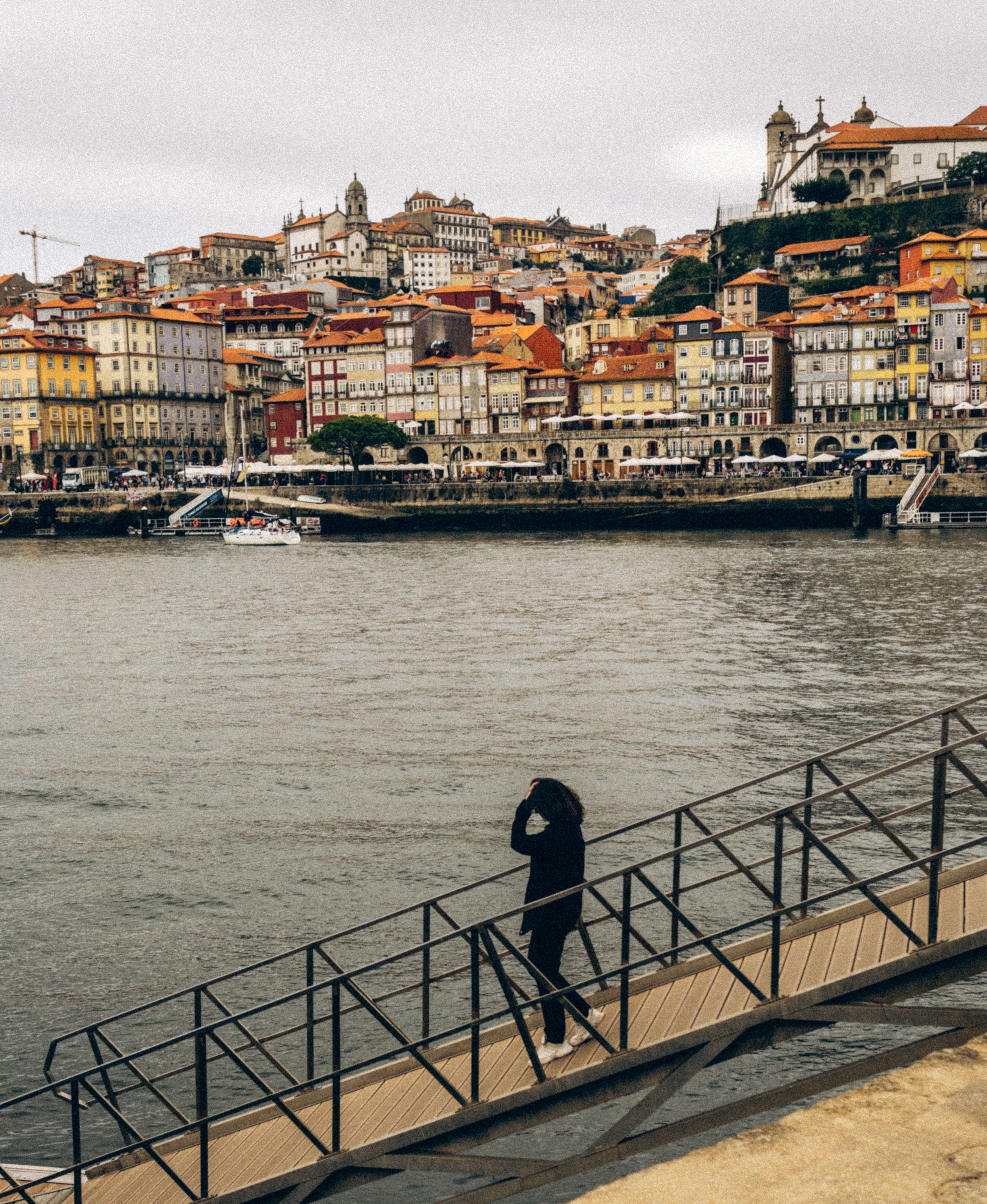 Person Walking Down a Bridge in Porto · Free Stock Photo