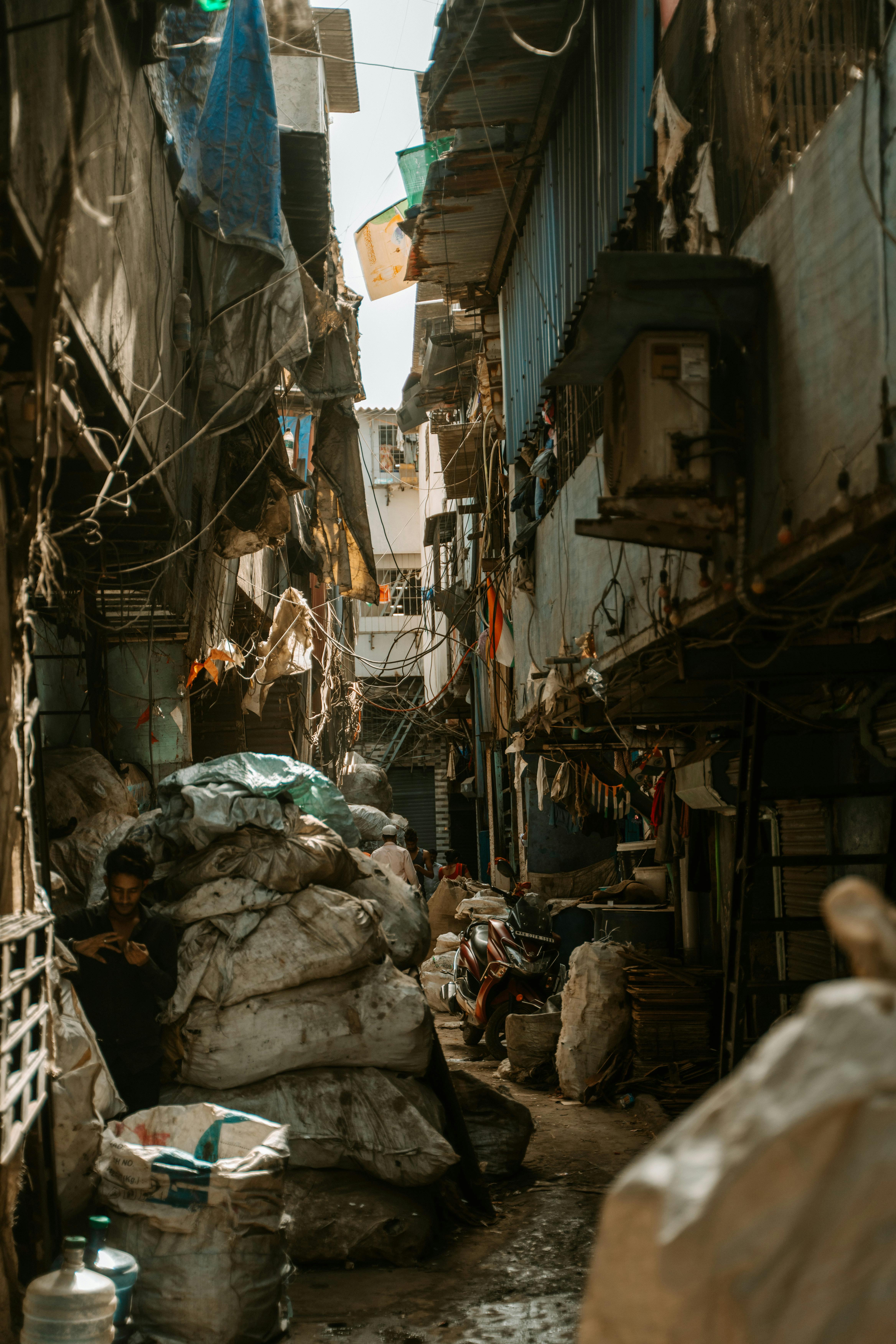 View of a Trashed, Narrow Alley between Buildings · Free Stock Photo