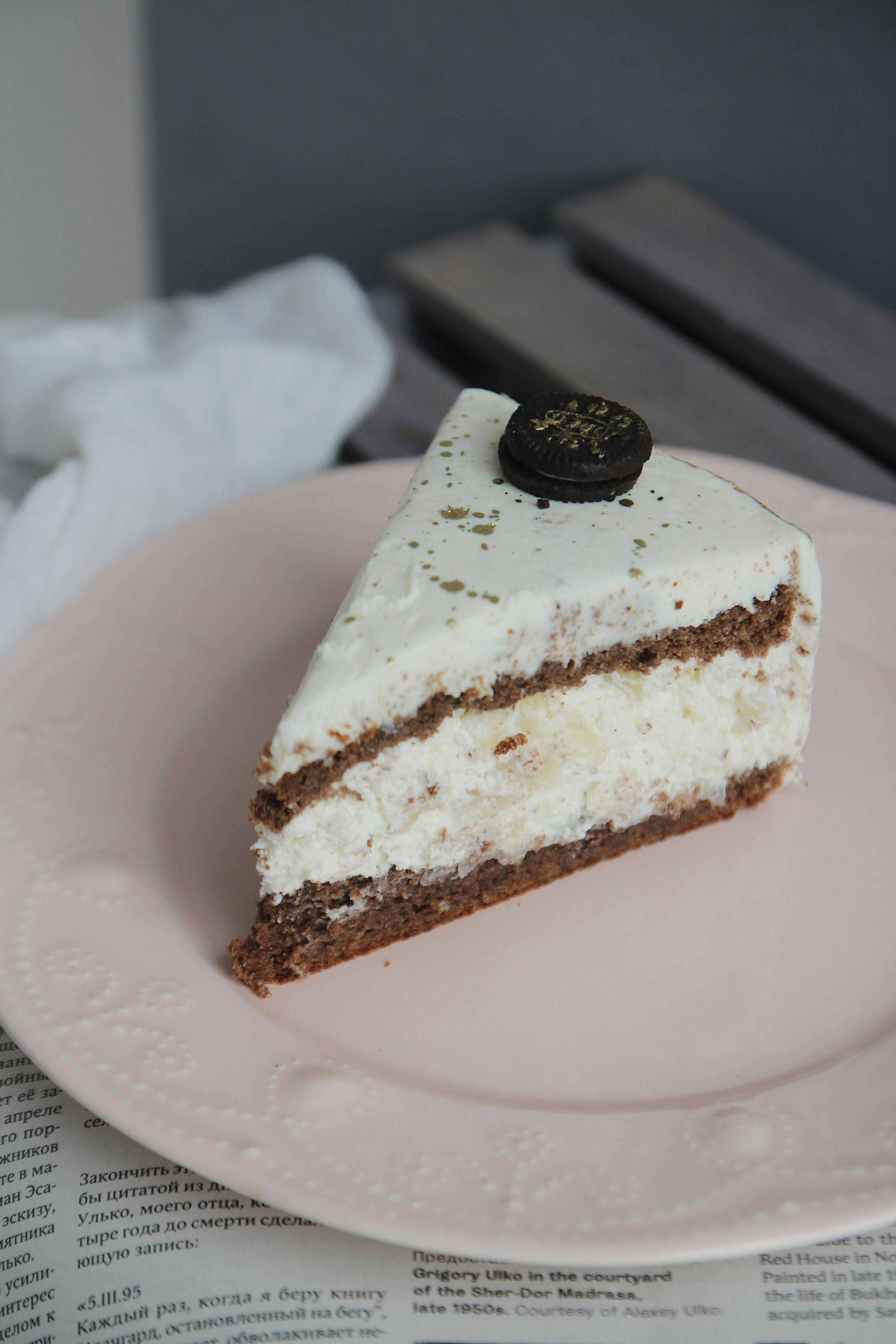 Sliced White and Pink Icing Covered Cake on White Plate With Silver ...