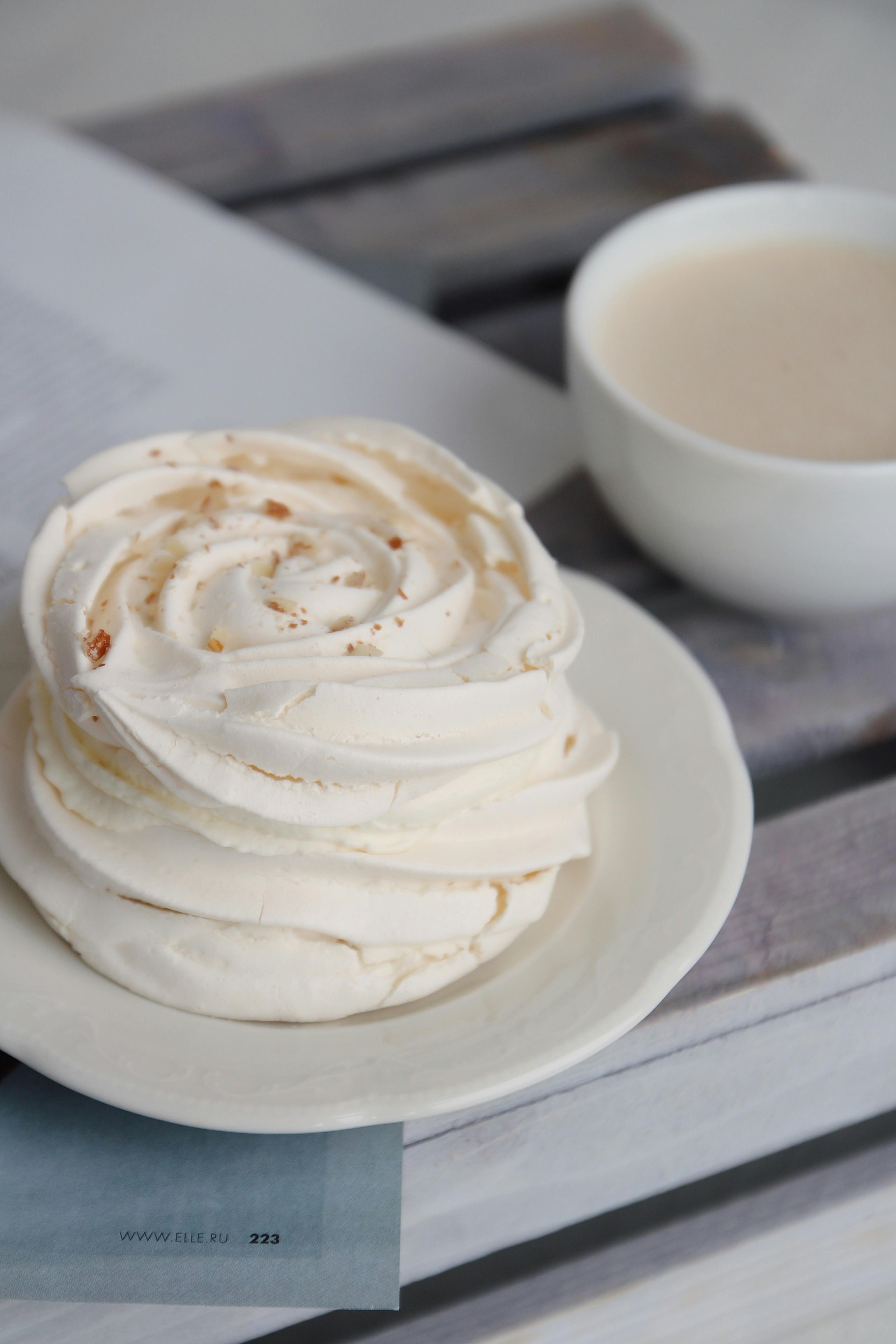 Cup of Cappuccino and Yellow Mochi on Paper · Free Stock Photo