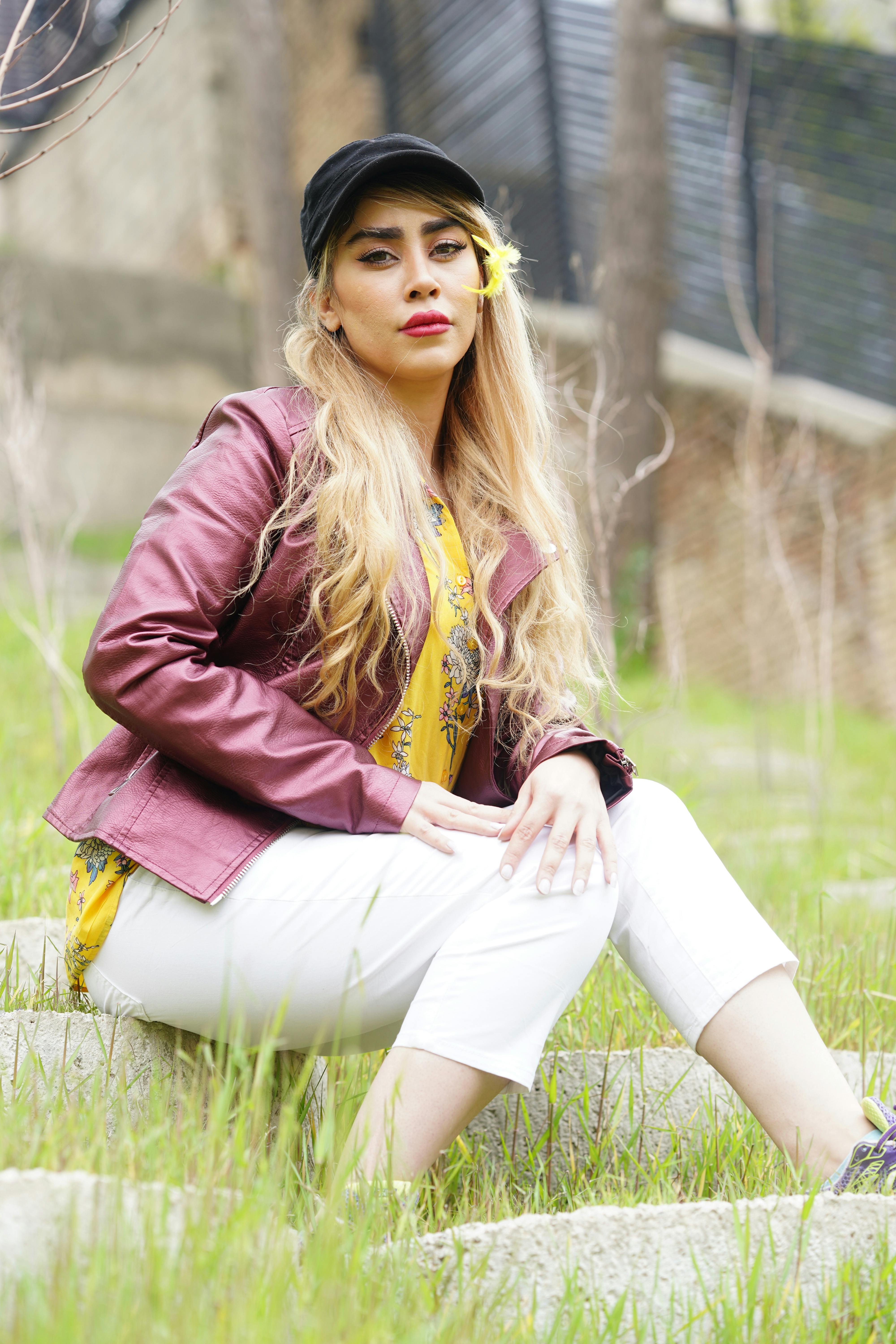 A Woman Wearing a Black Cap and White Jacket · Free Stock Photo