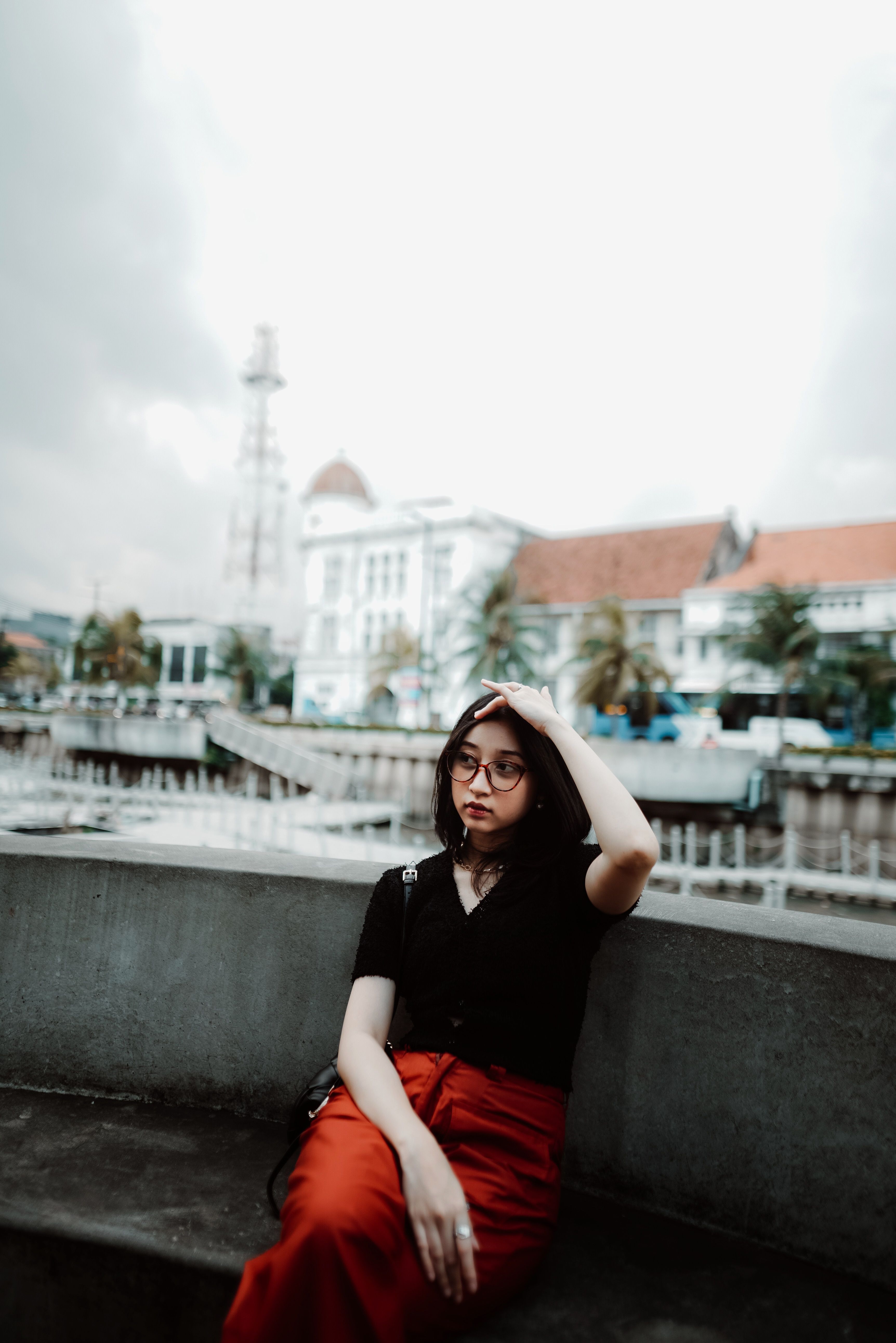 Young Brunette Sitting by the River in a City · Free Stock Photo