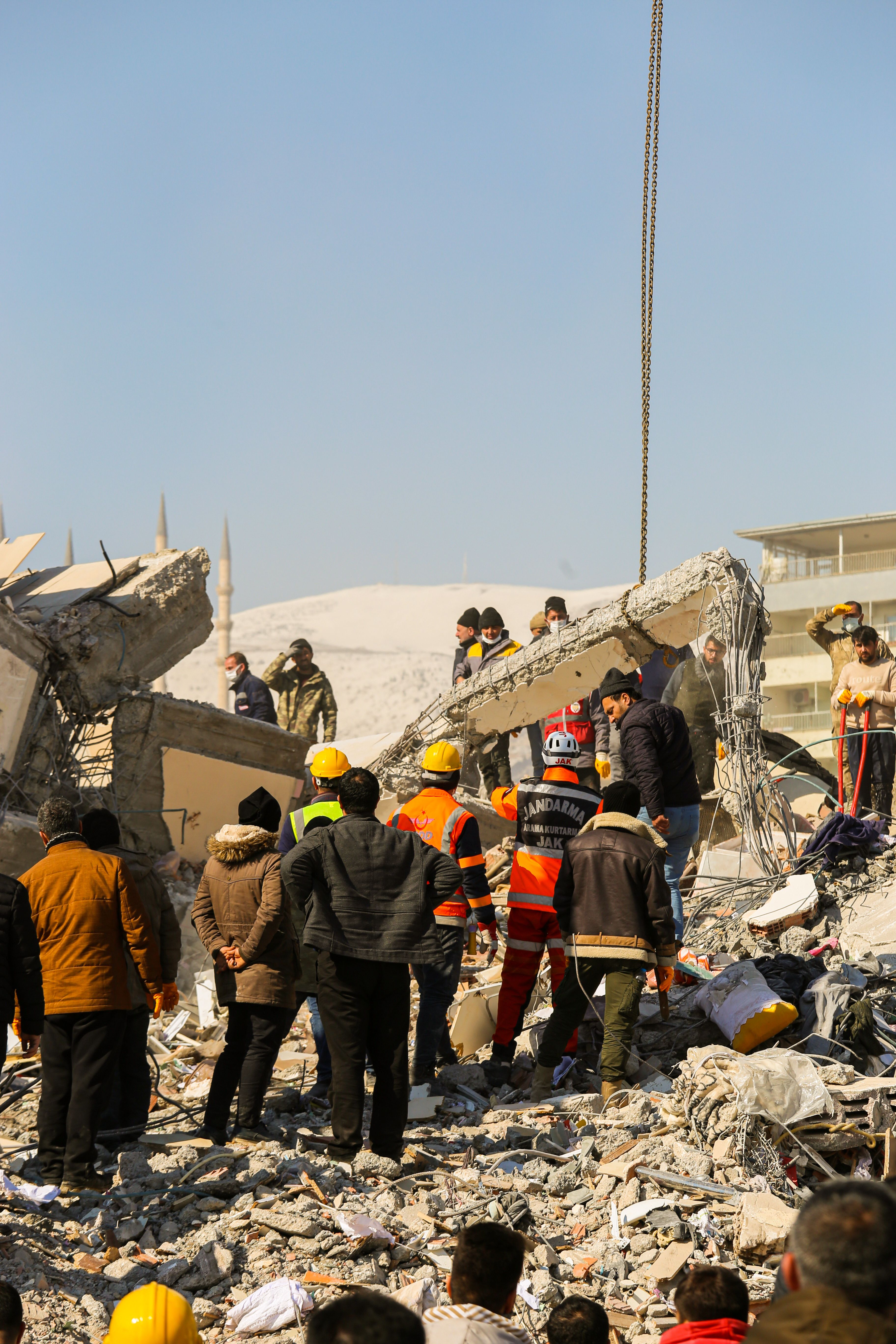 People gather around the rubble of a building · Free Stock Photo