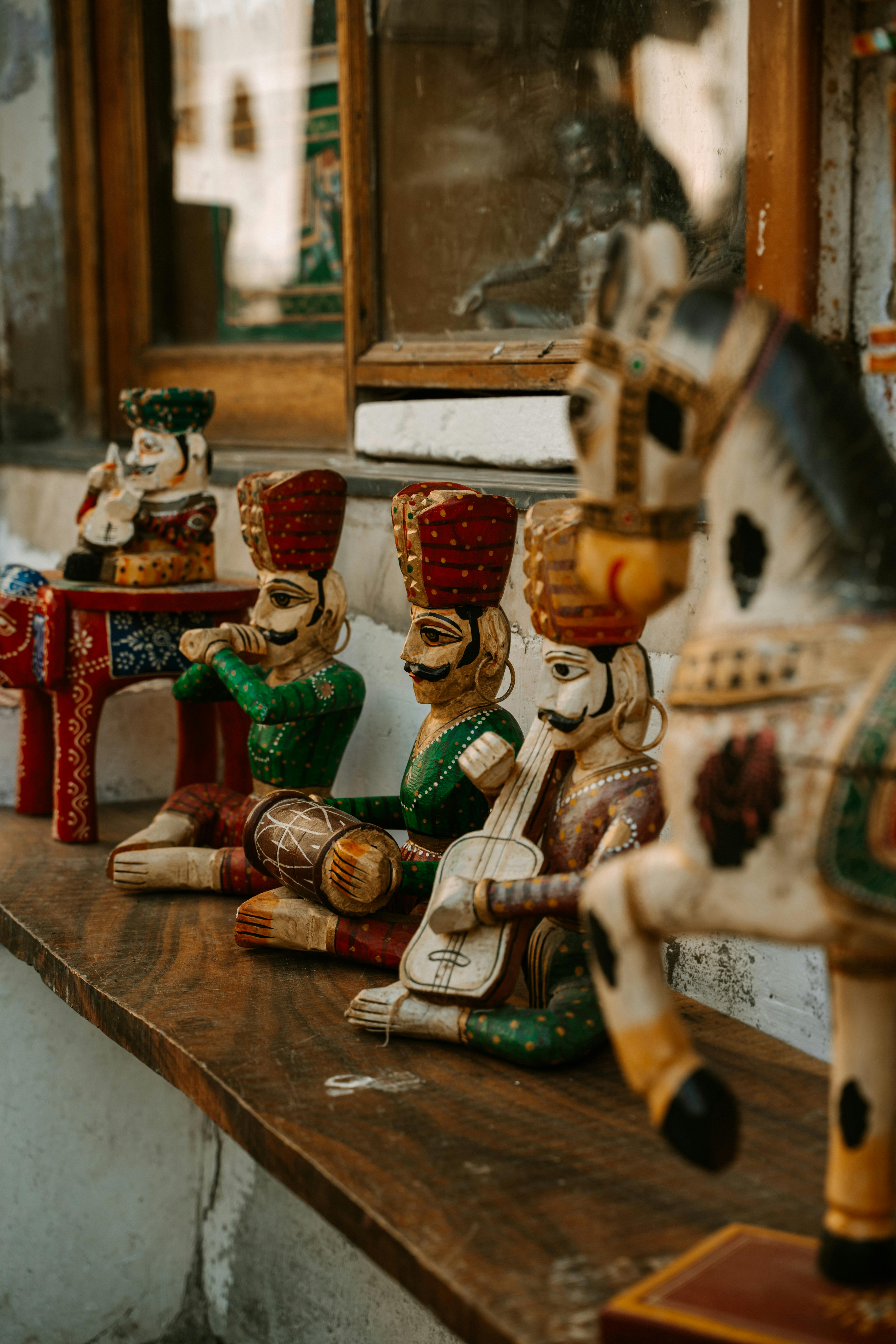 Photo of Traditional Indian Folk Puppets on a Shelf · Free Stock Photo
