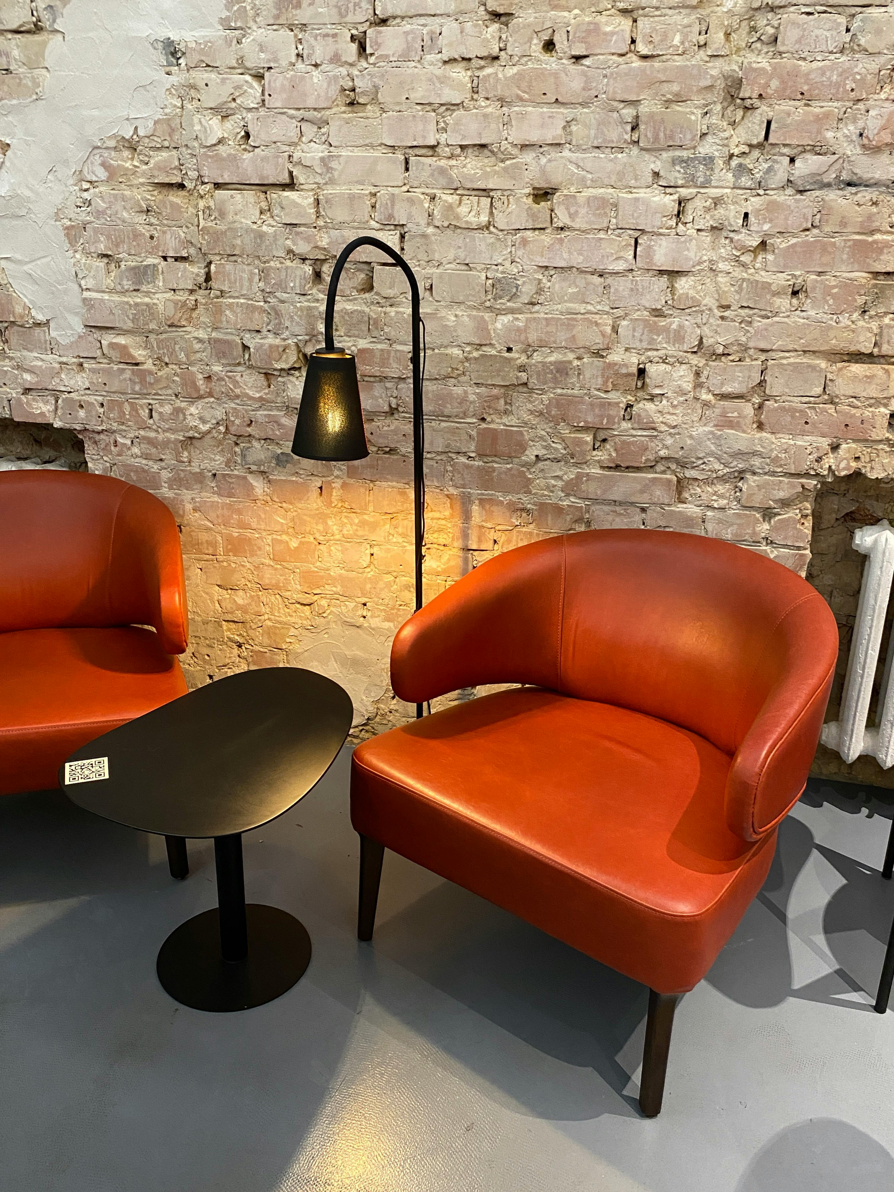 Seats by the Brick Wall in a Modern Cafe · Free Stock Photo