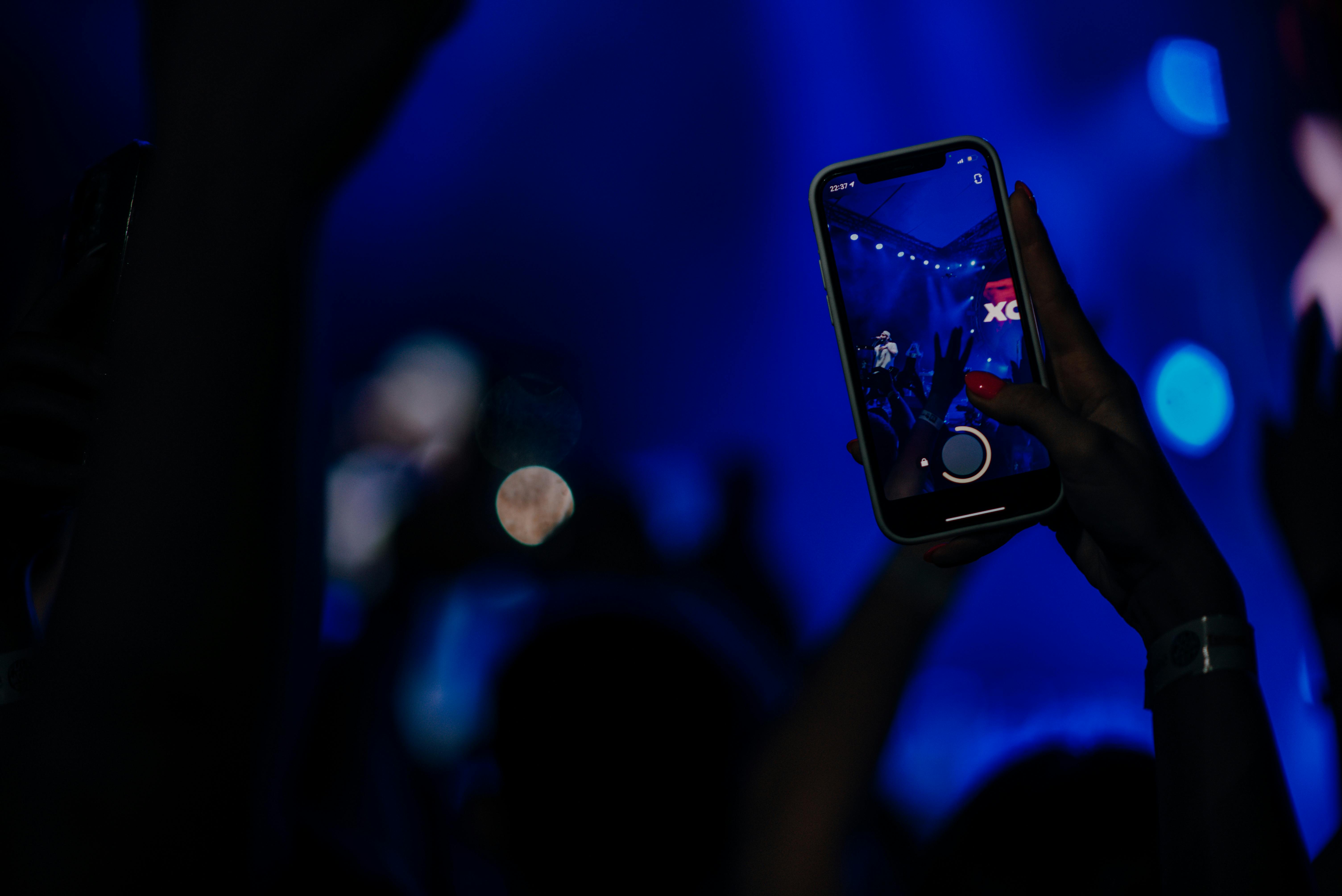 Person Recording Concert with Smartphone · Free Stock Photo