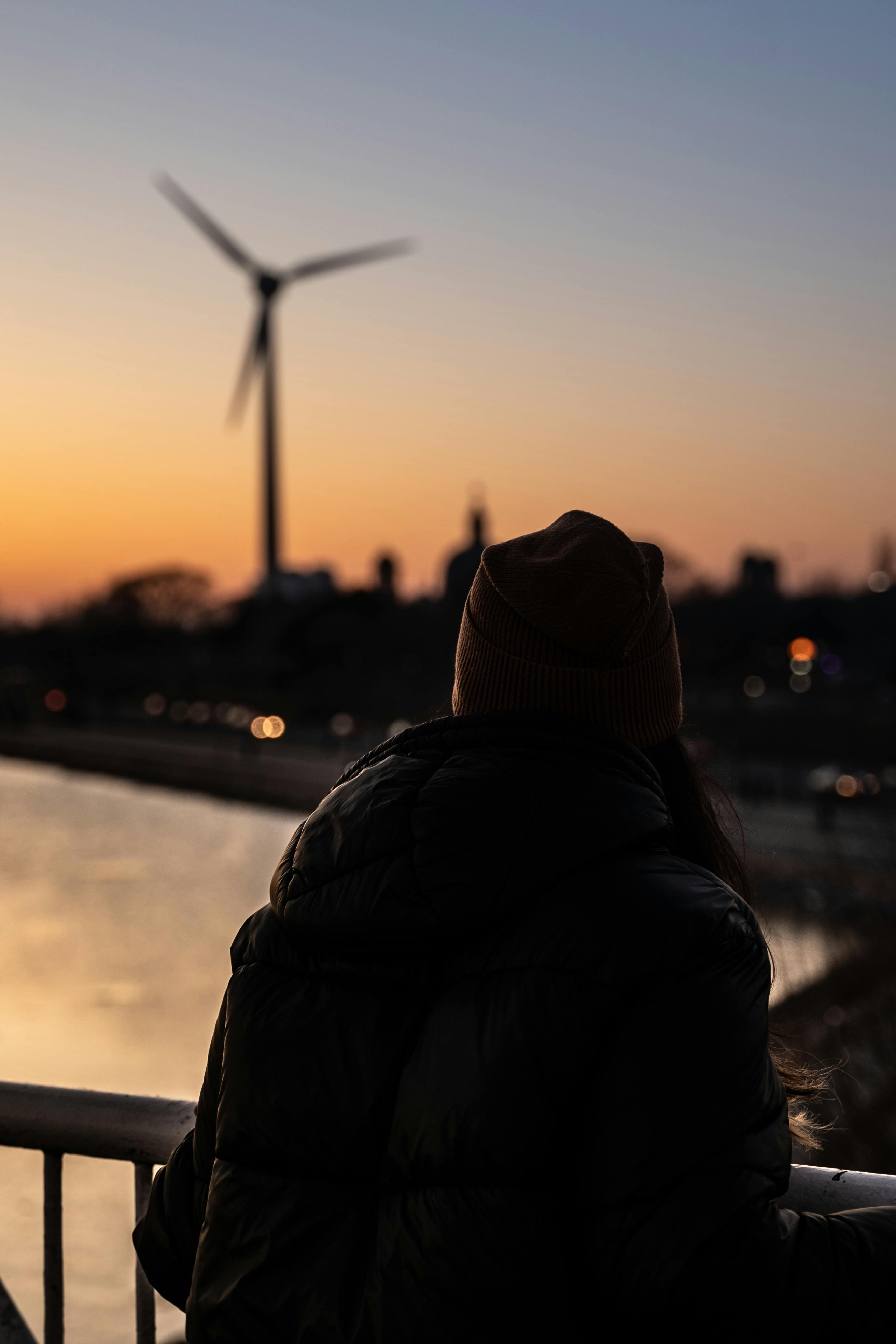 Person Standing with River behind at Sunset · Free Stock Photo