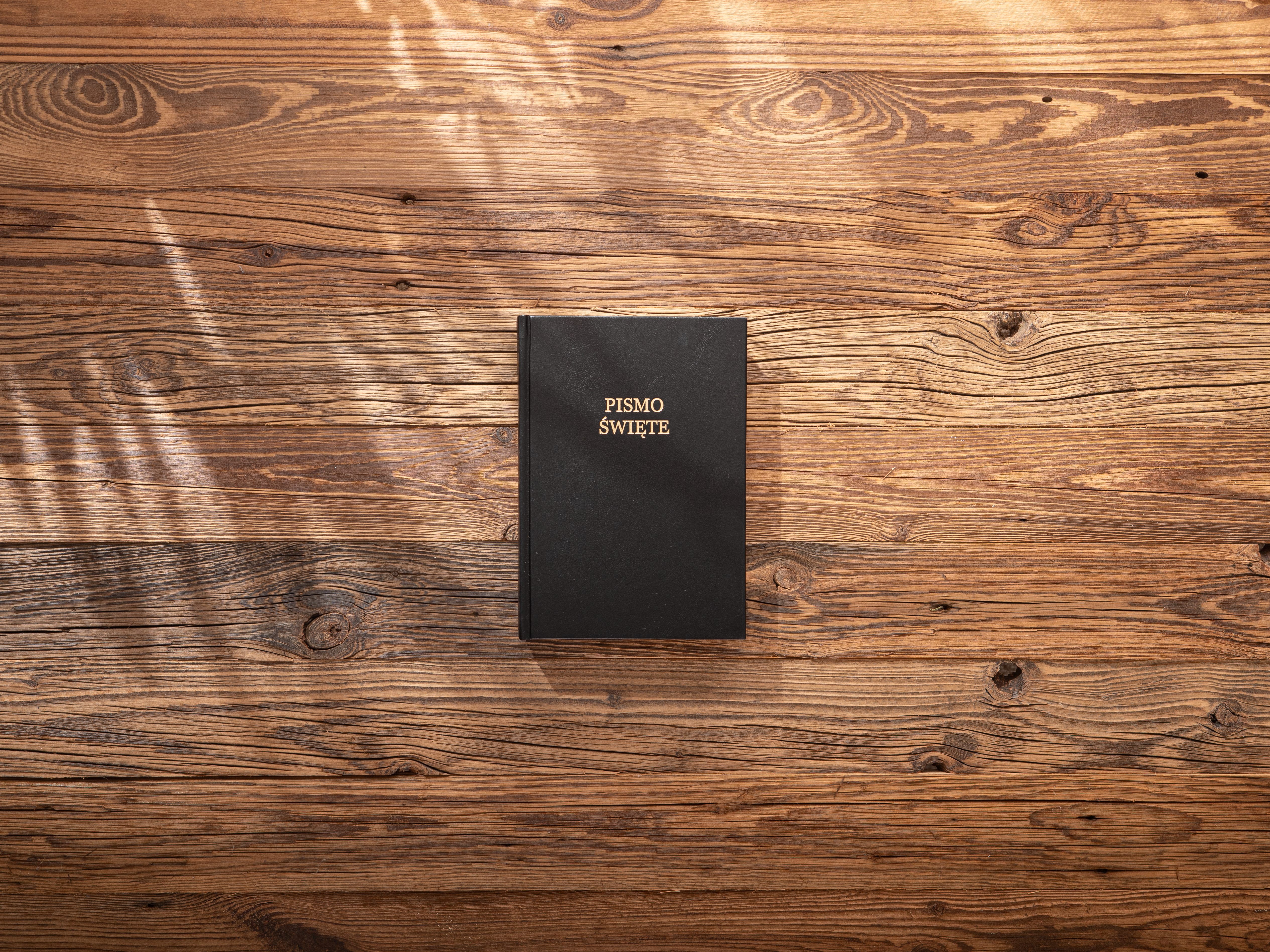 Free Polish Bible placed on a textured wooden surface with natural ...