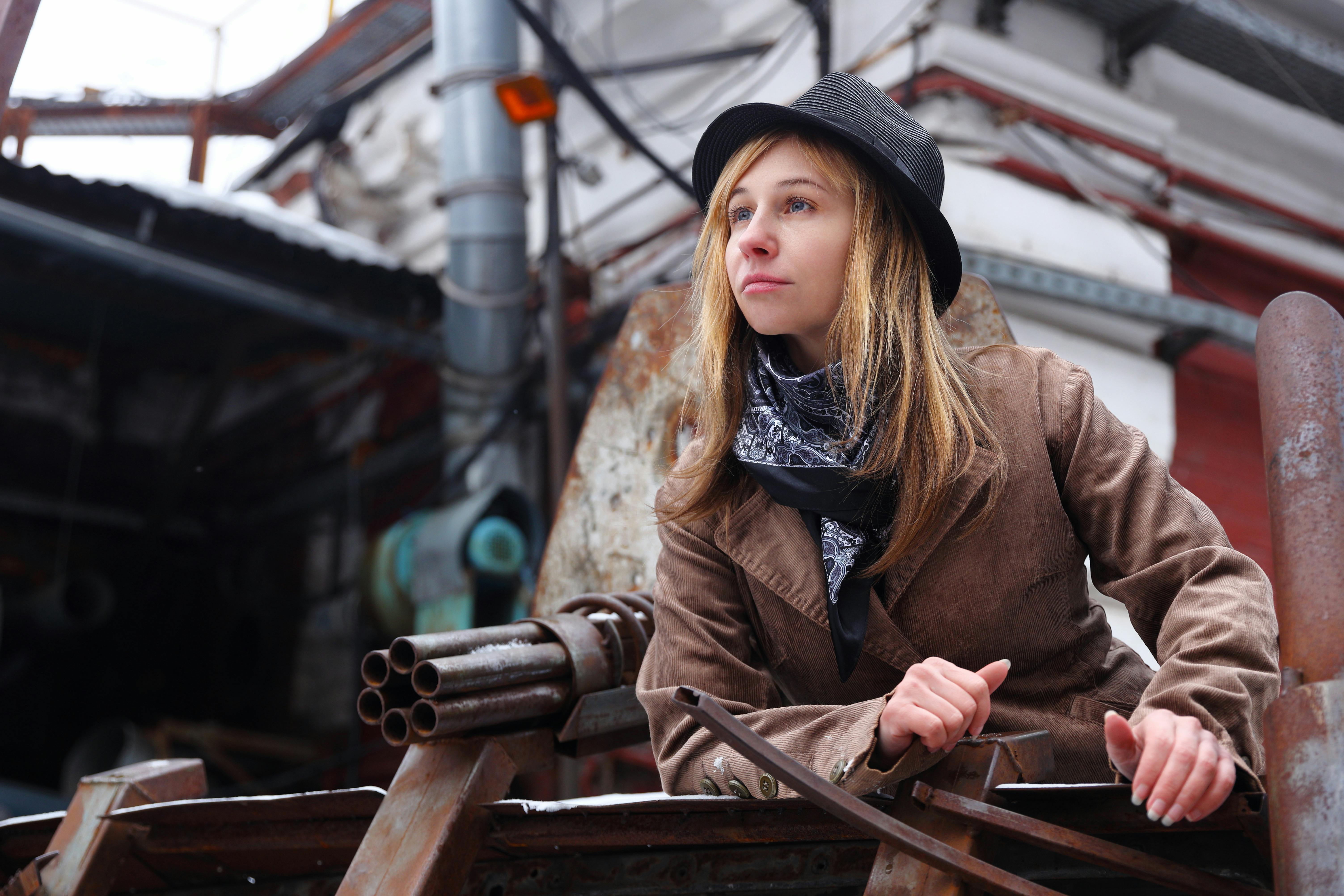 Woman Posing near Rusty Machine Gun · Free Stock Photo