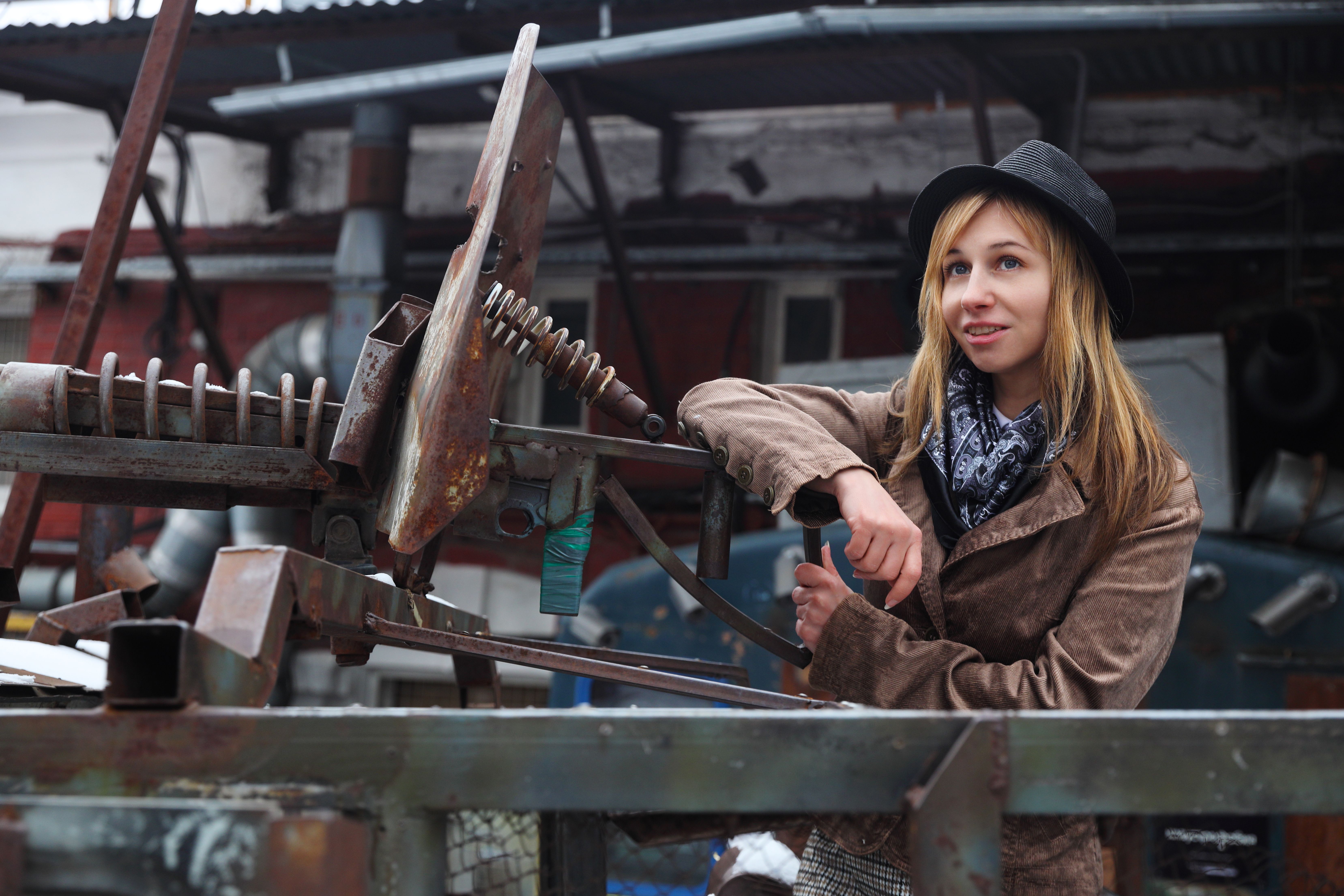 Woman Posing near Rusty Machinery · Free Stock Photo