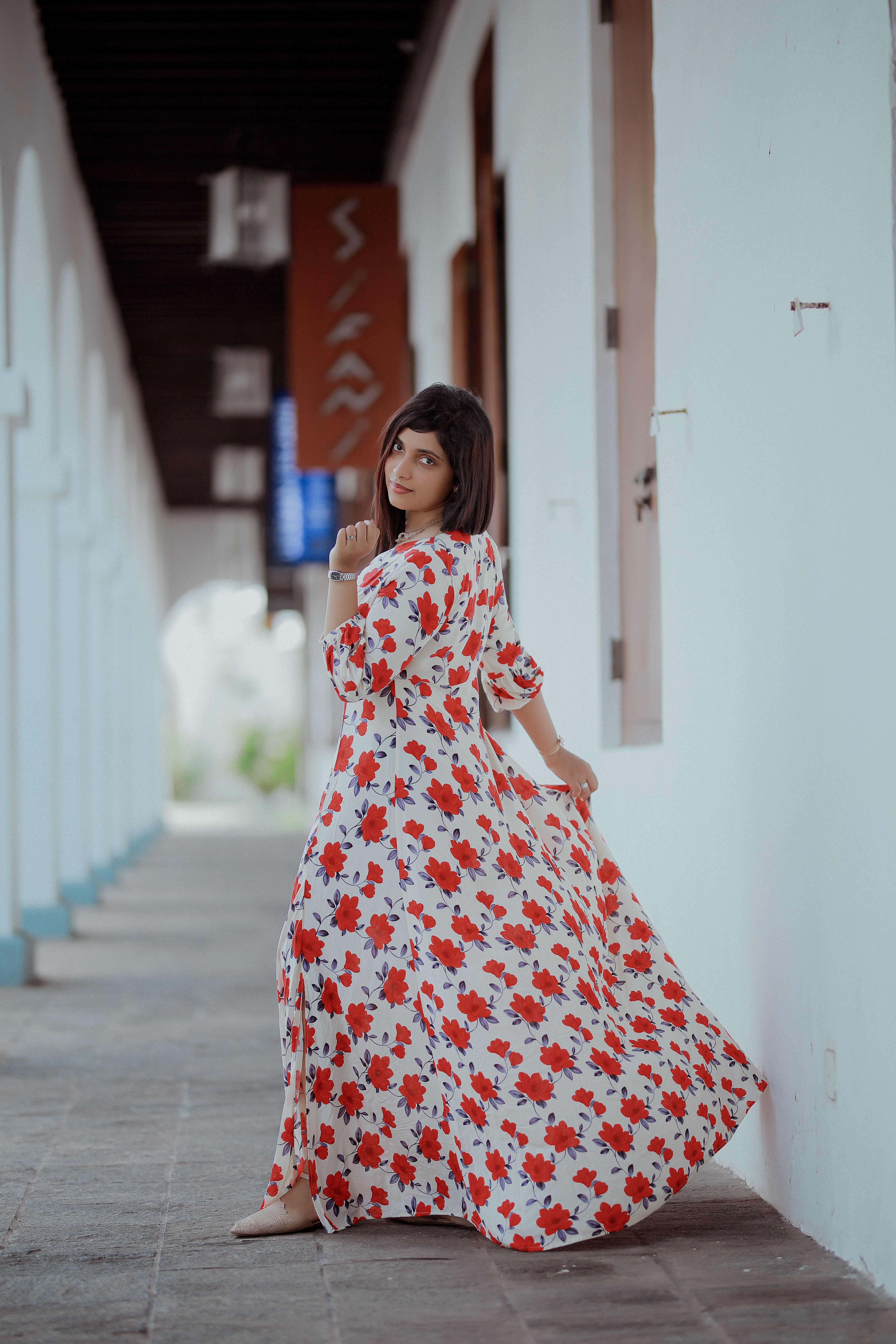 Model Posing in Long Dress with Floral Pattern · Free Stock Photo