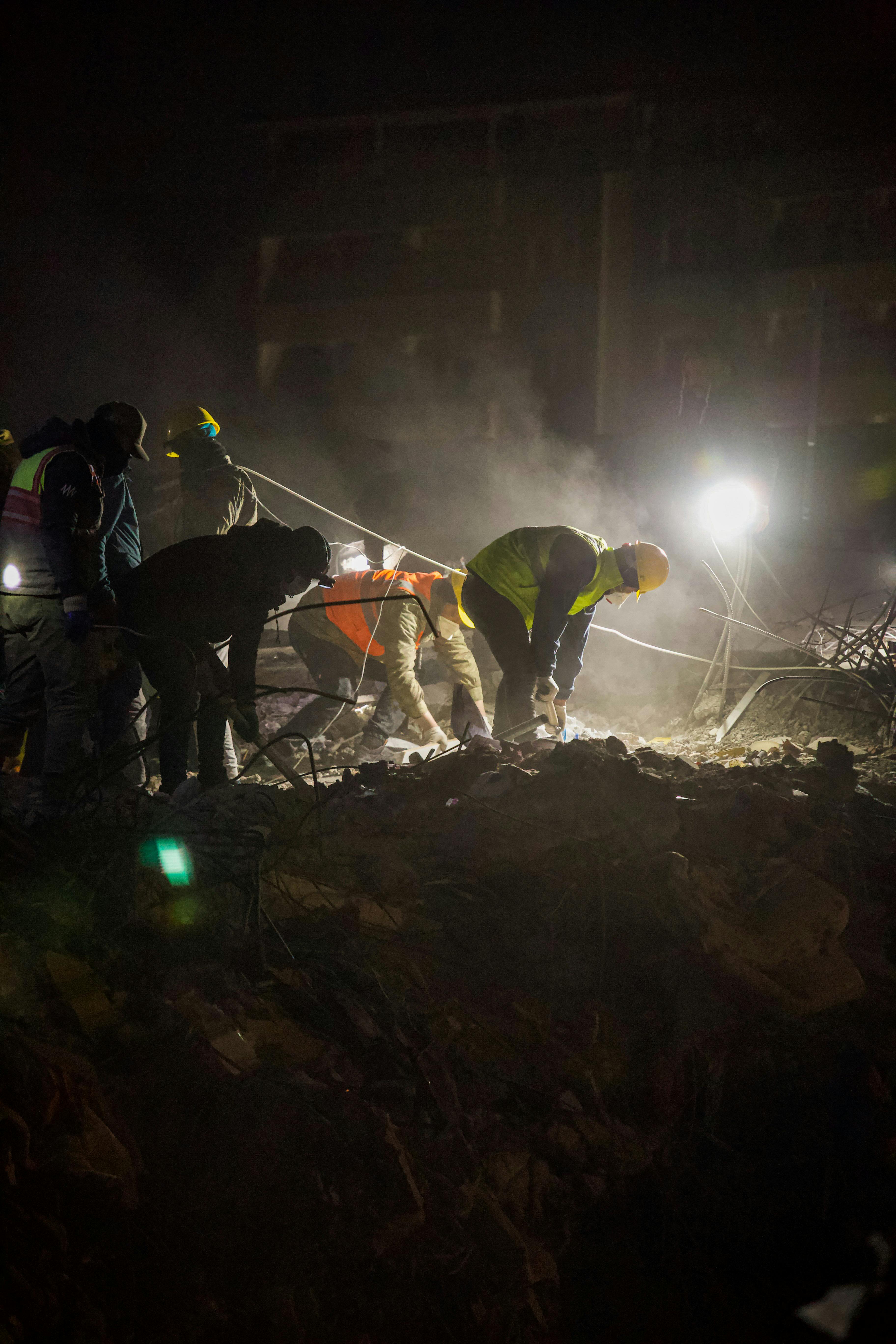 Men Working on a Construction Site at Night · Free Stock Photo