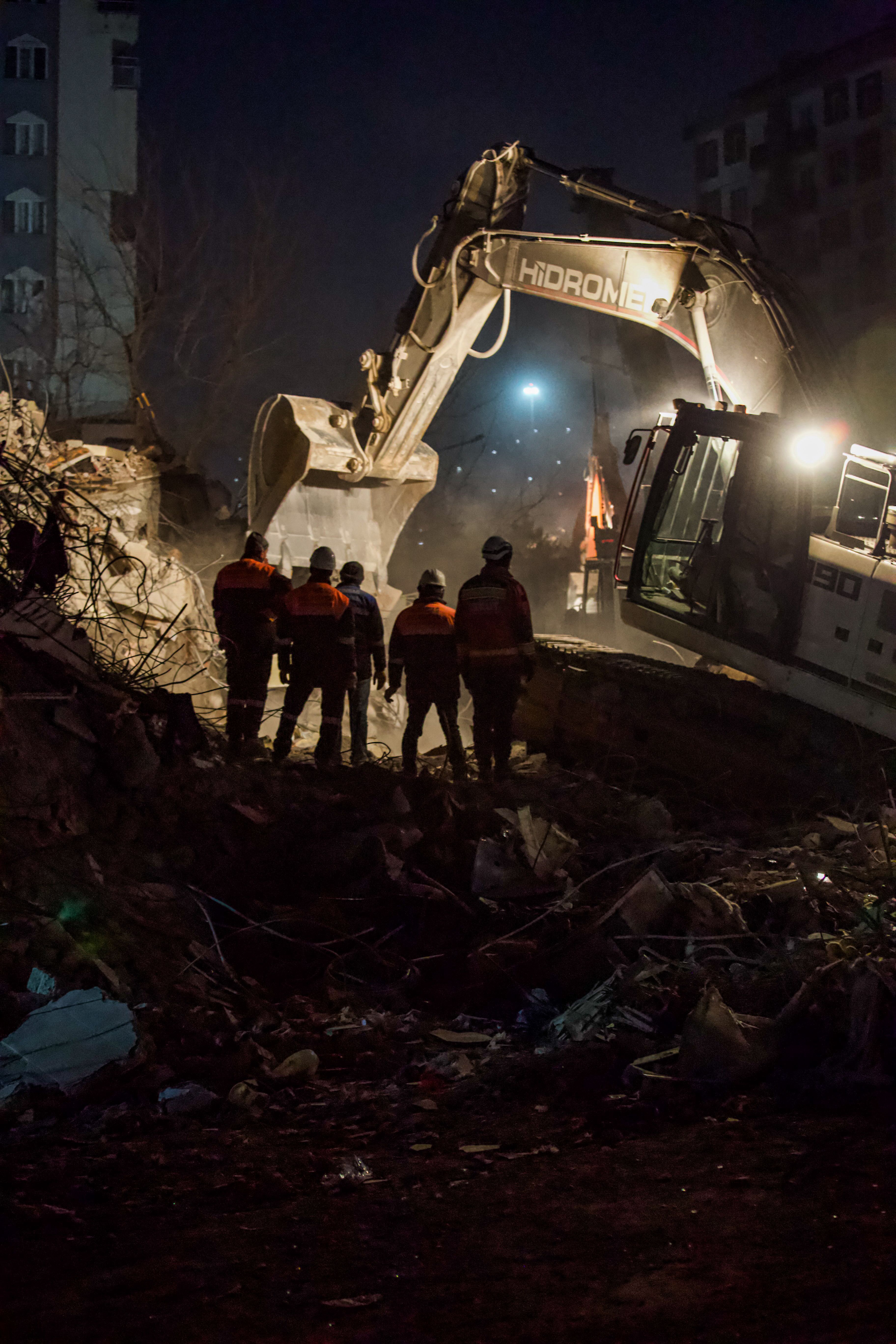 A group of people standing in front of a bulldozer · Free Stock Photo