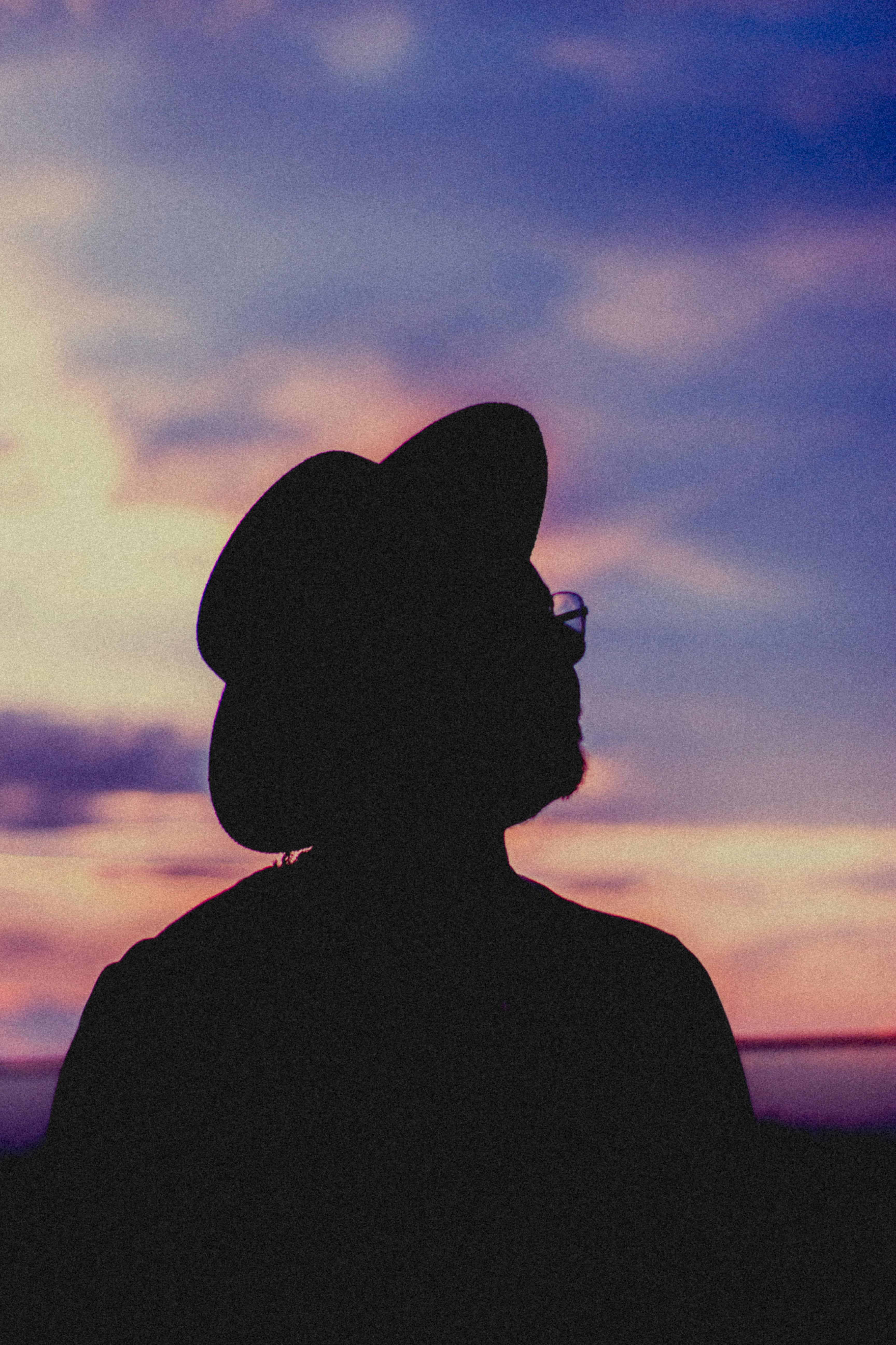Silhouette of Man in Hat · Free Stock Photo