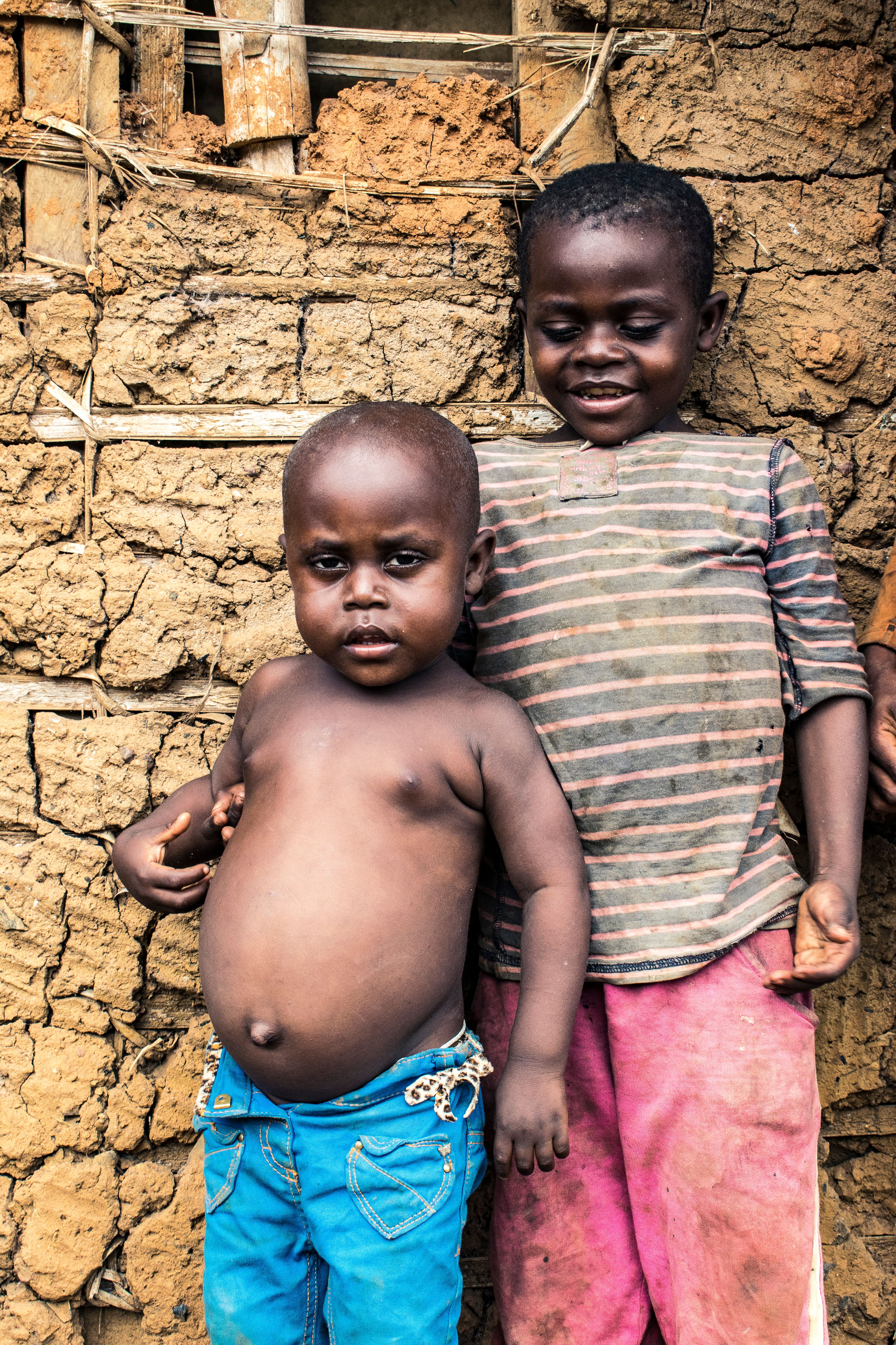 Photo of Two Boys Standing against a Wall · Free Stock Photo