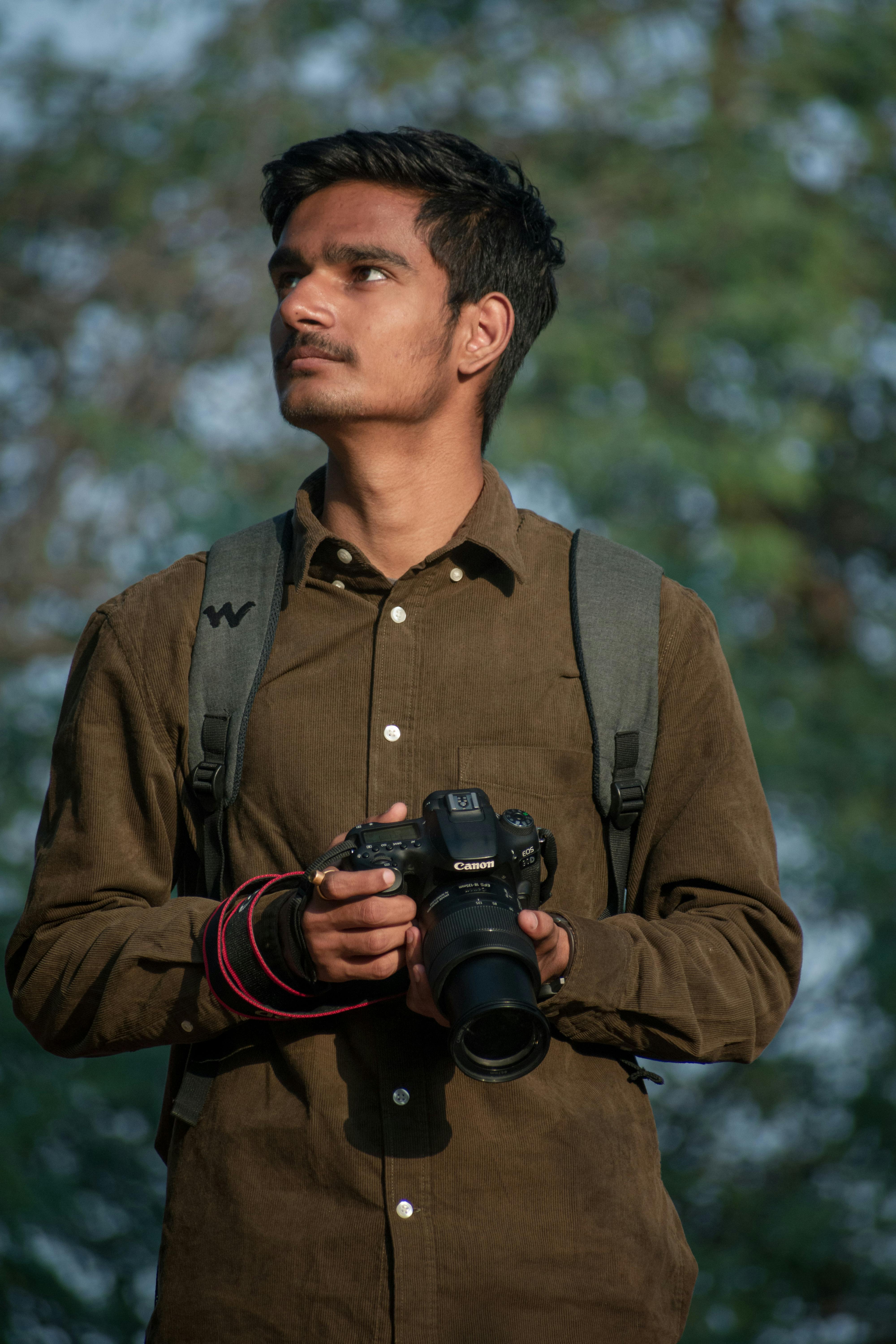 Man Holding Black Canon Dslr Camera Taken · Free Stock Photo