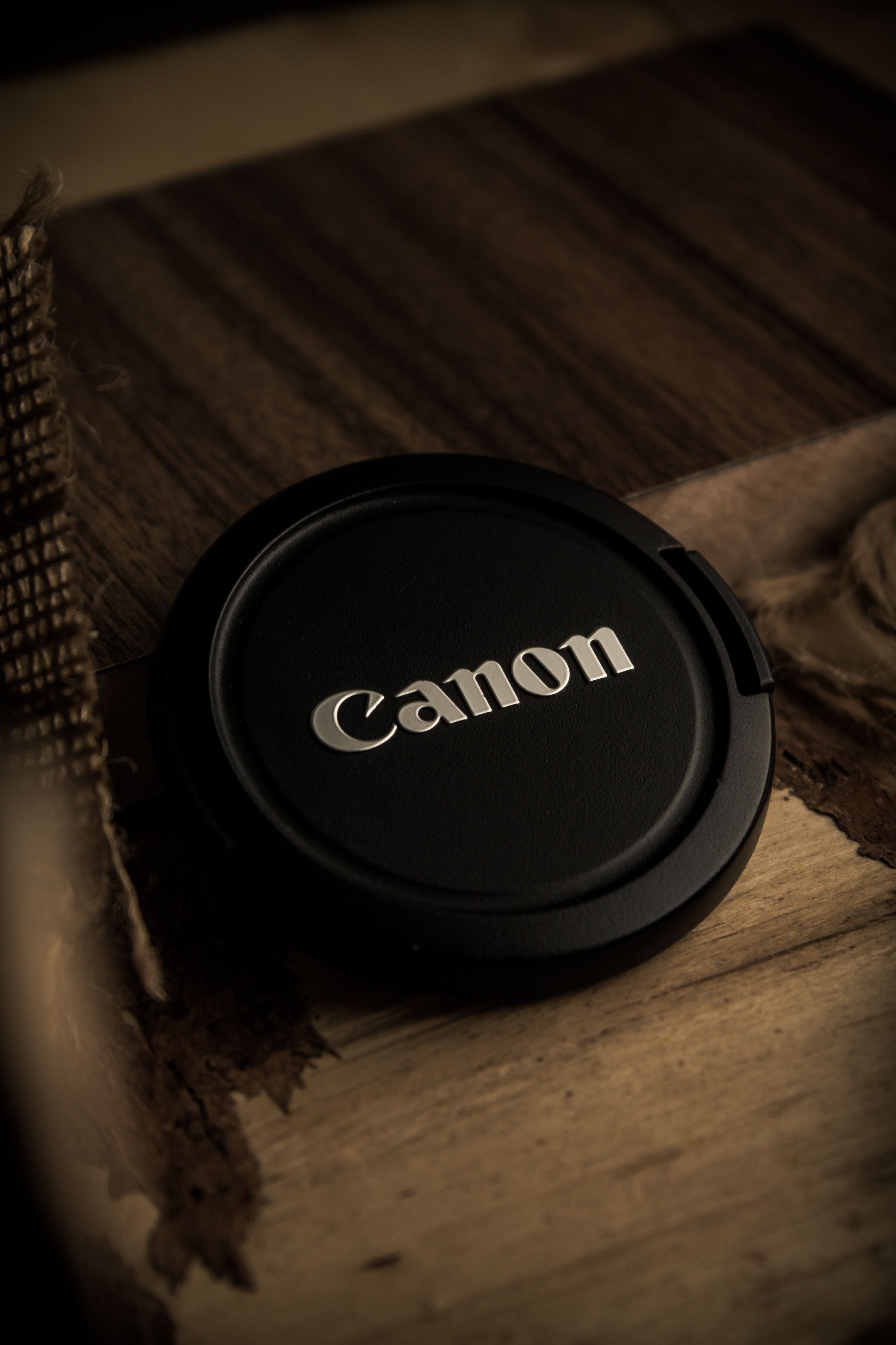 Black Canon 50mm Camera Lens On Table · Free Stock Photo