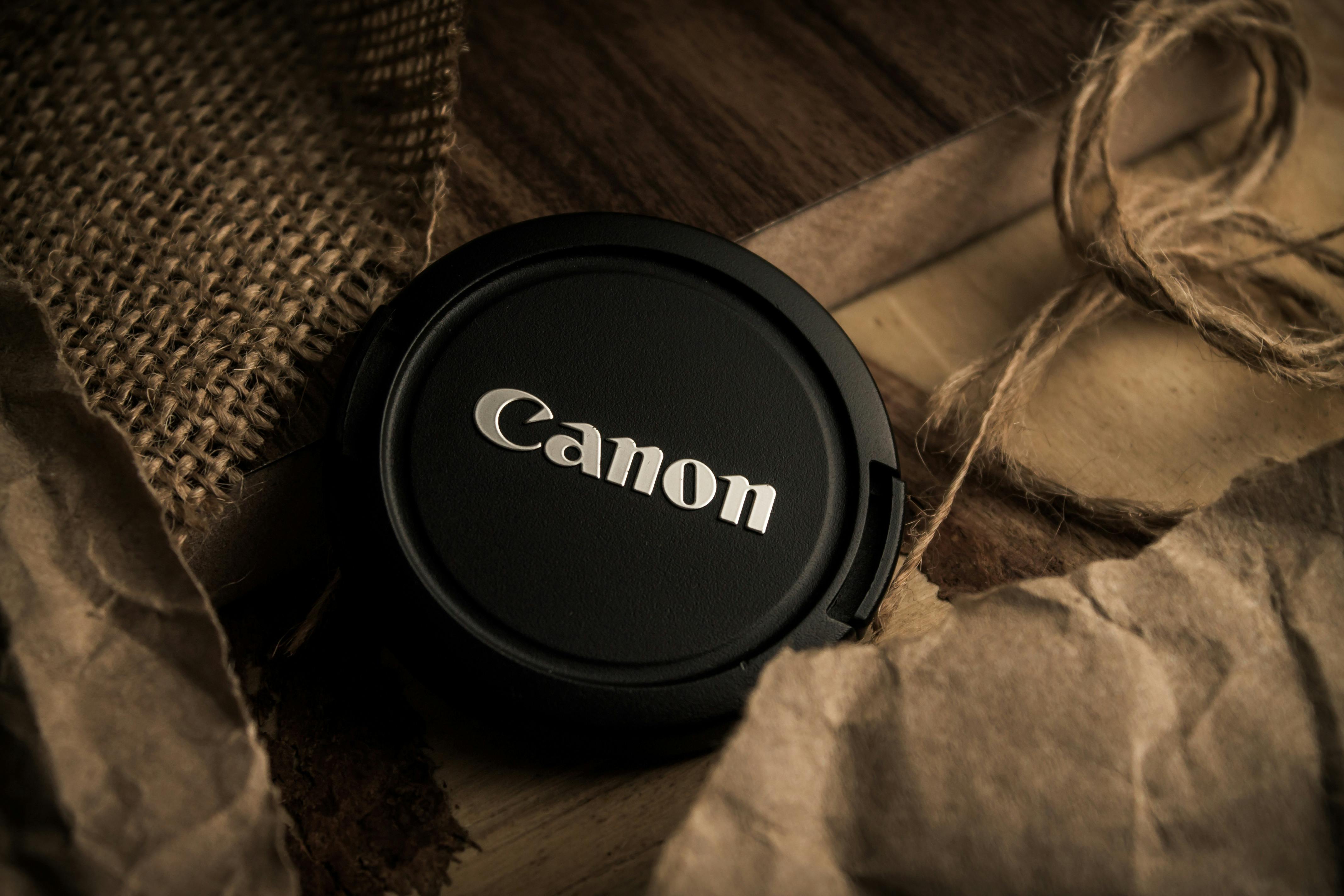 Black Camera Lens Cap on Brown Paper · Free Stock Photo