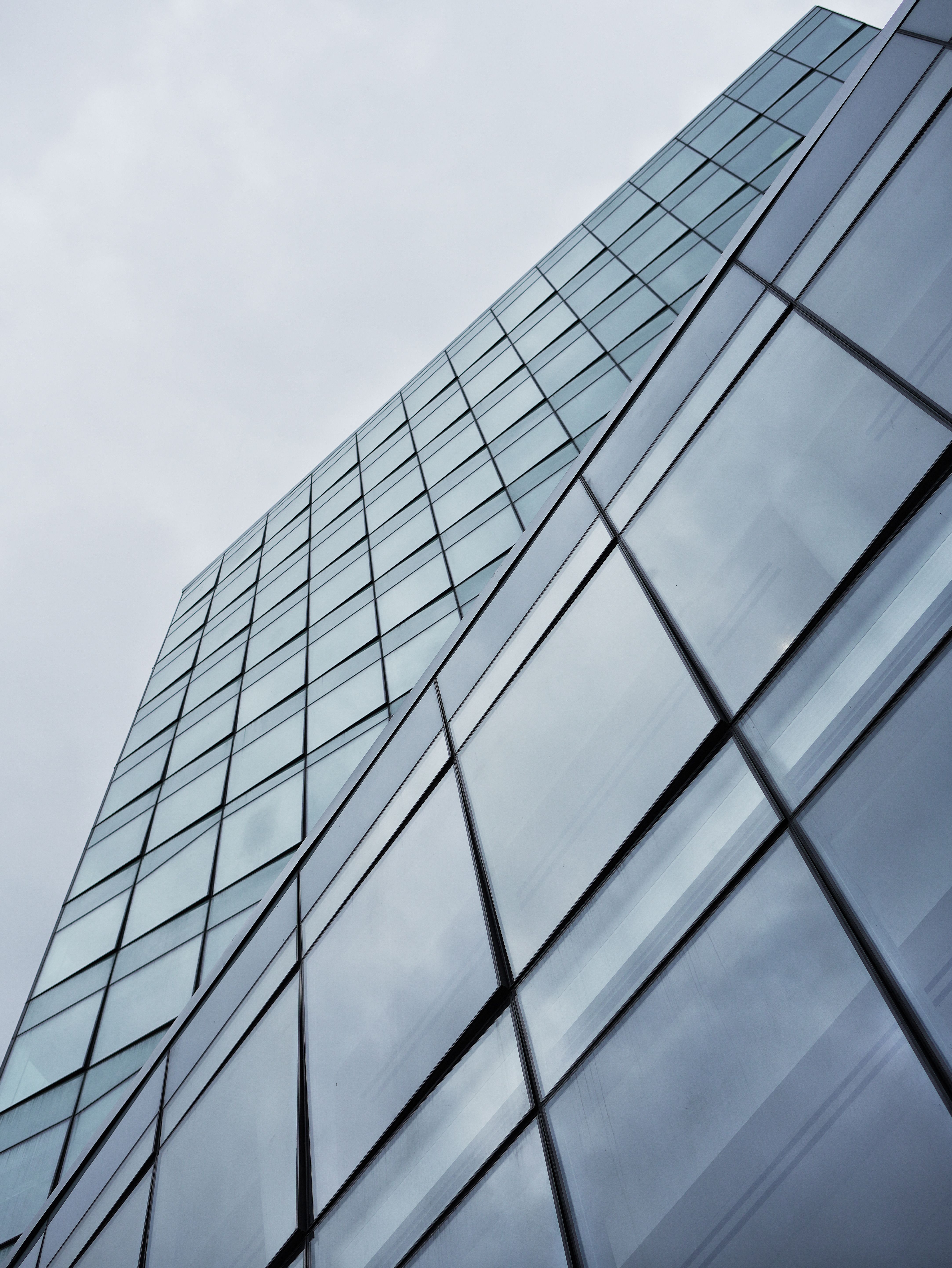 Low Angle Shot of a Man Wearing Black Suit Posing By a Skyscraper with ...