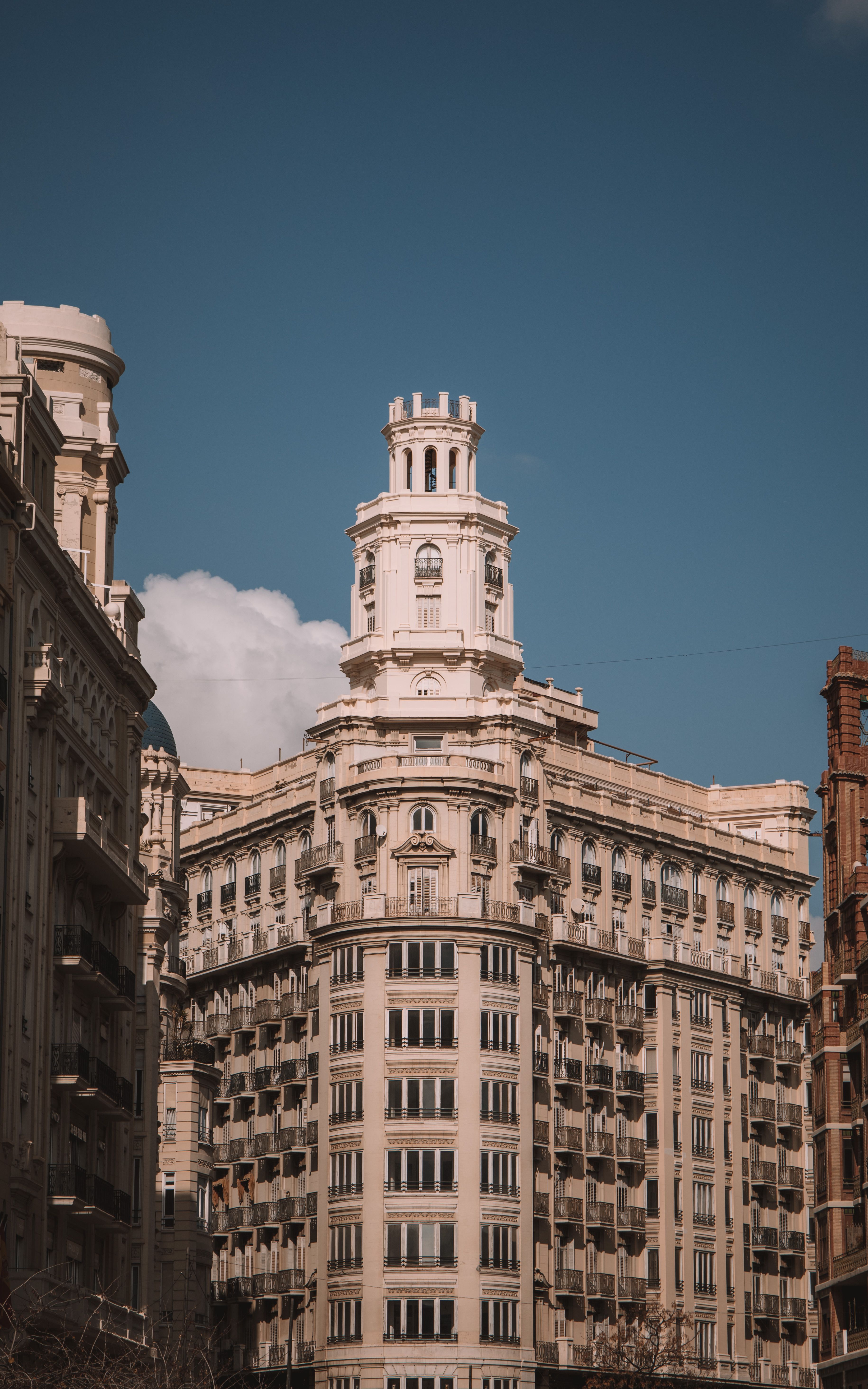 Clear Sky over Buildings with Sunlit Tower in Town · Free Stock Photo