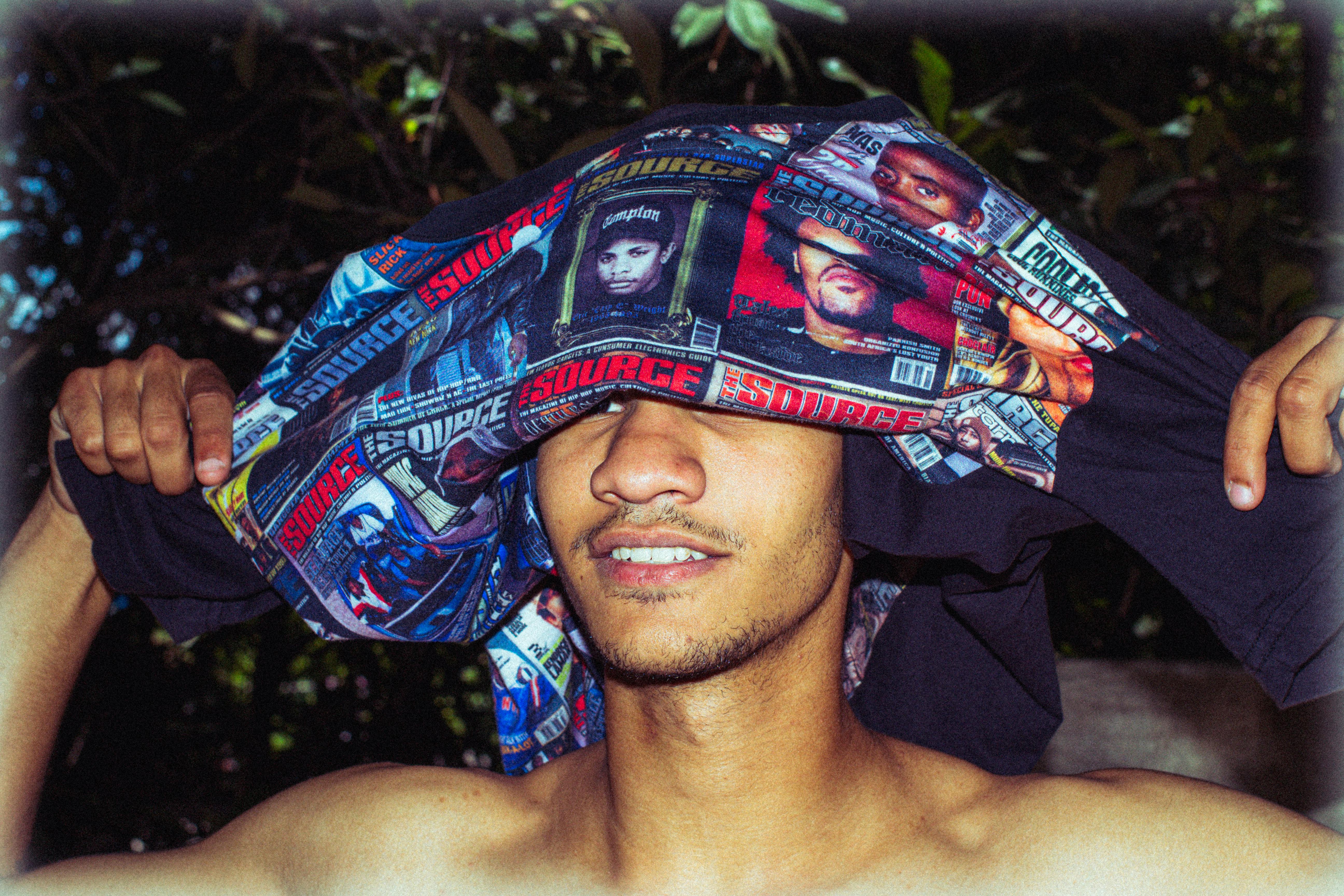 Photo of a Shirtless Young Man with a Rap T-Shirt on His Head · Free ...