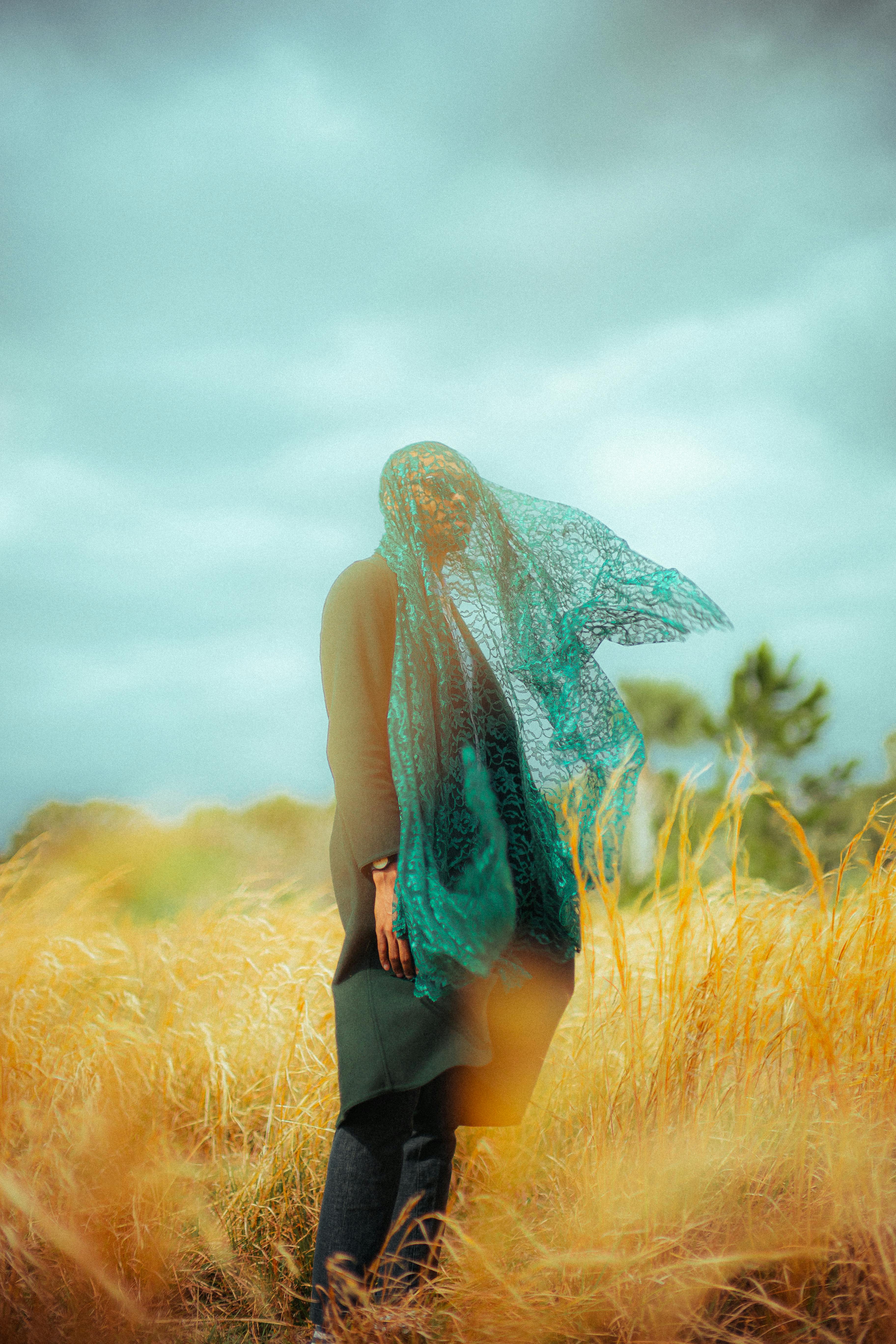 Man in Veil Standing among Grasses · Free Stock Photo