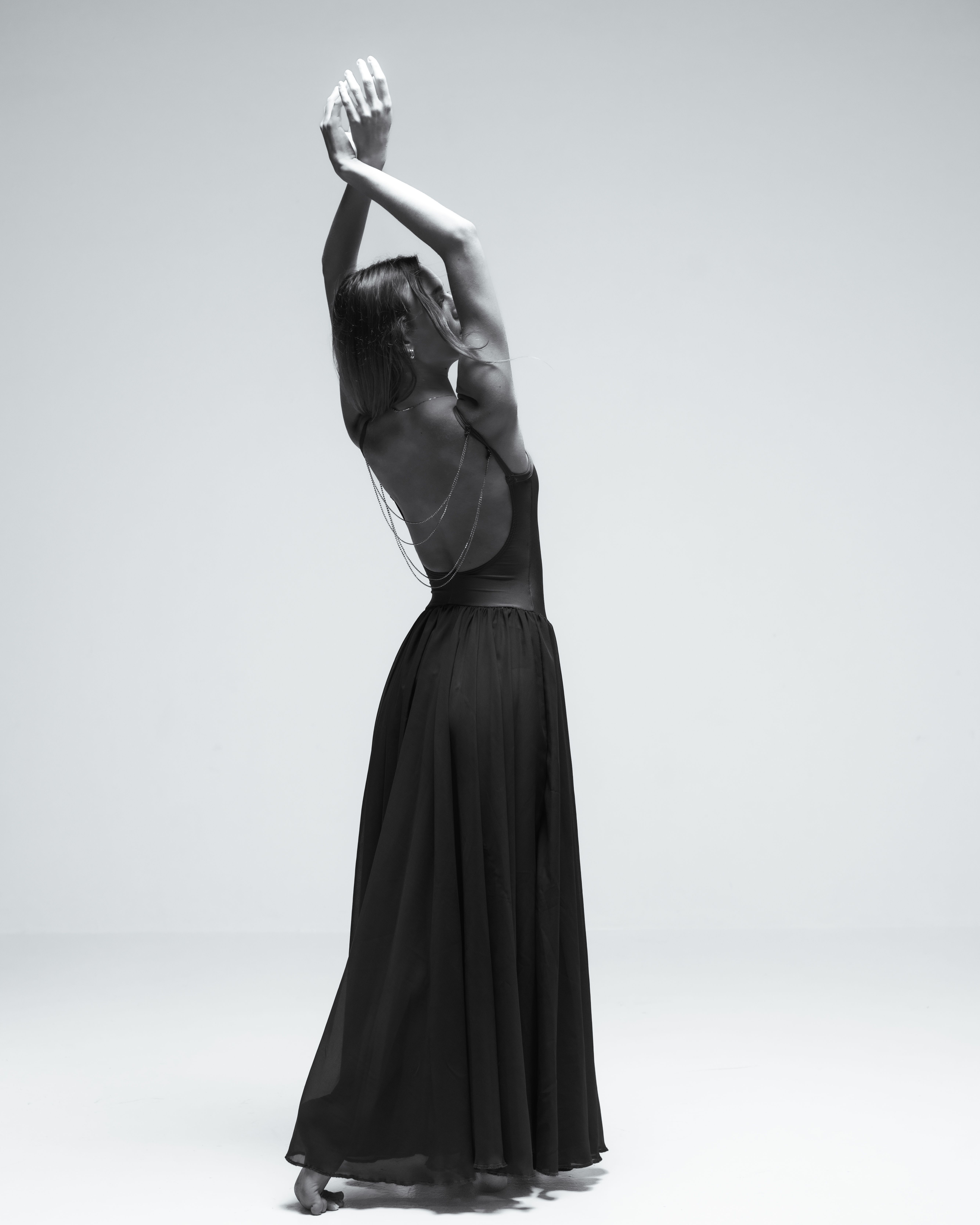 Woman in a Dress Posing with Her Arms Raised · Free Stock Photo