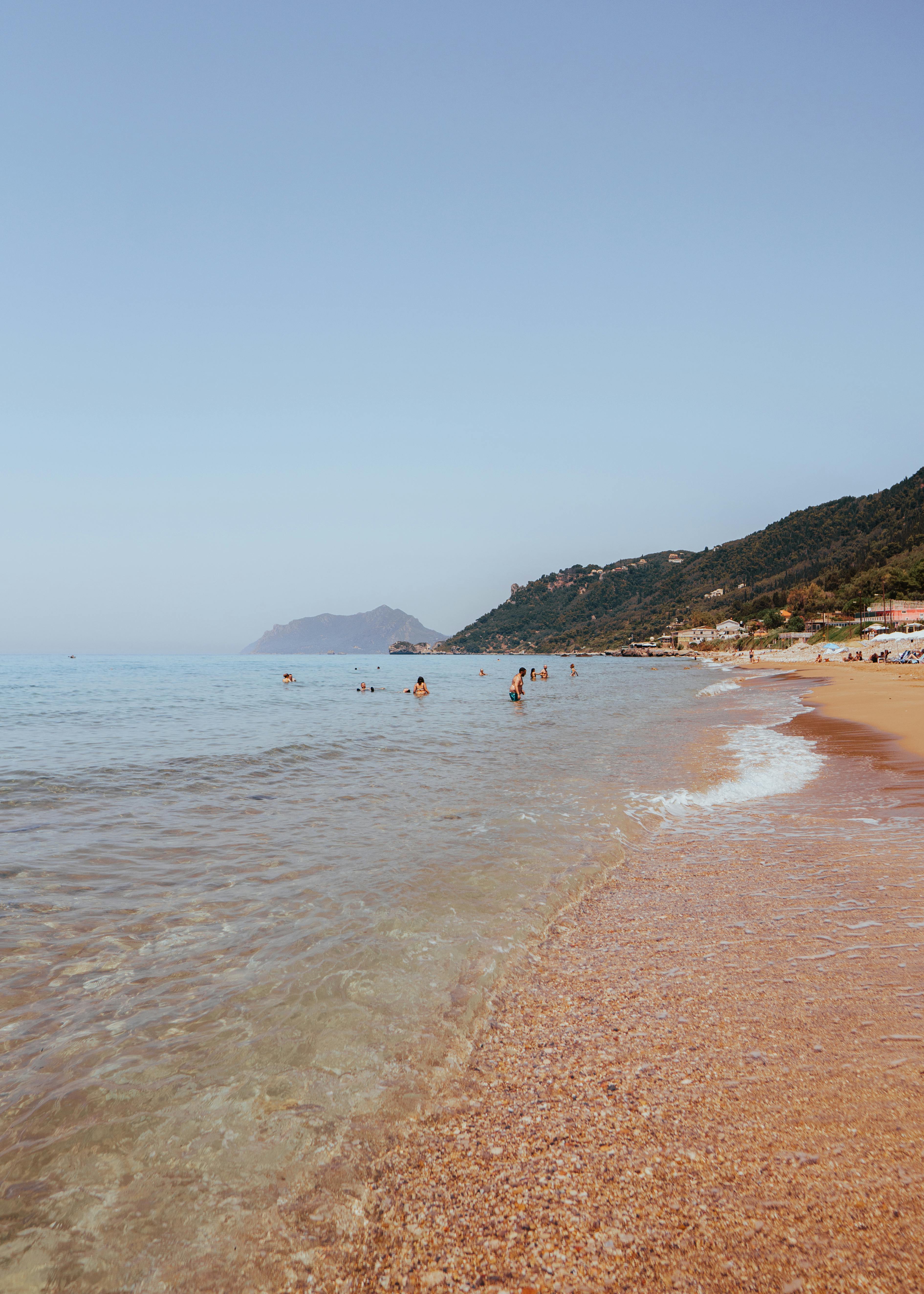 View of People Swimming in the Sea and Sunbathing on the Beach in Agios ...