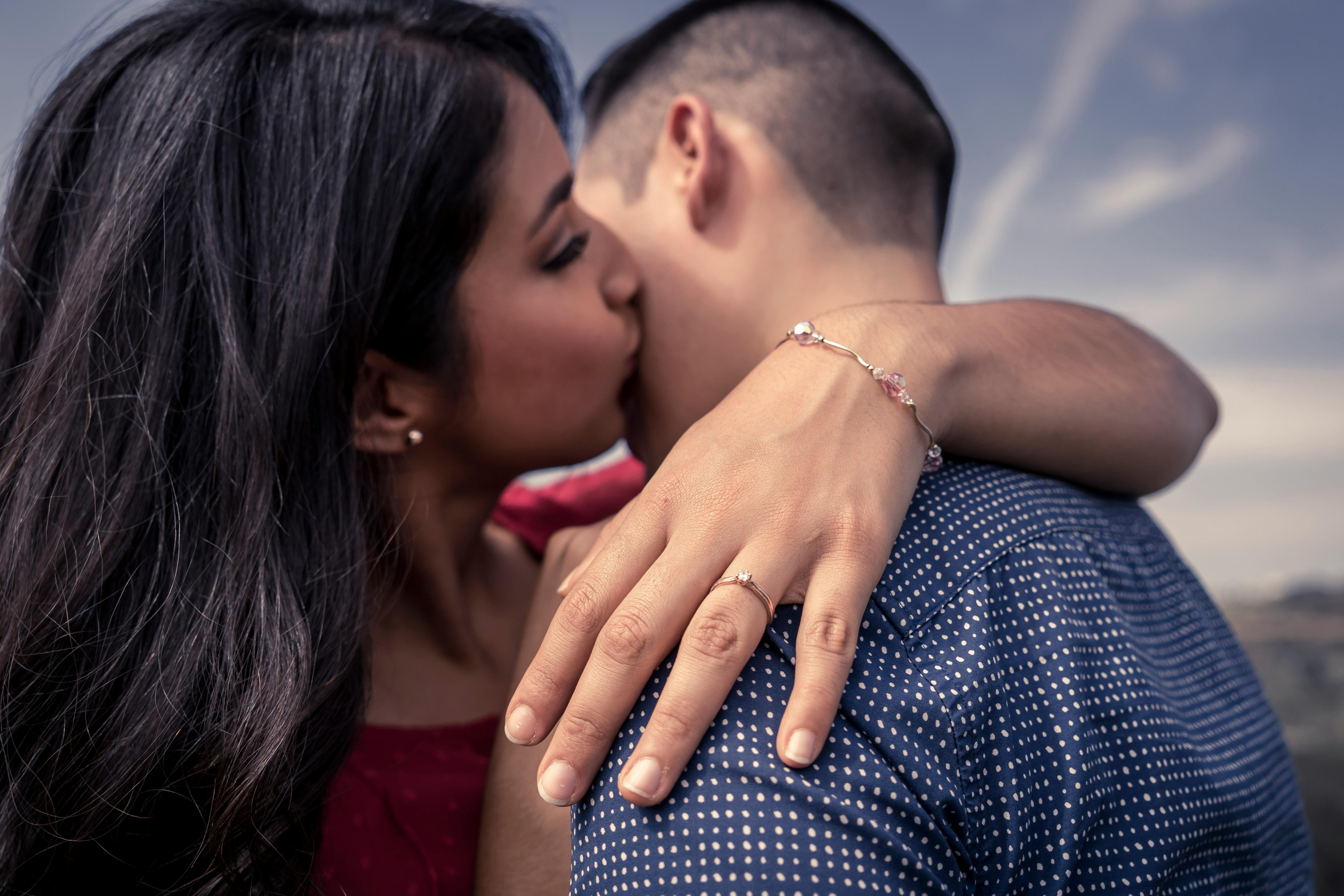 Man Kissing Girls Neck