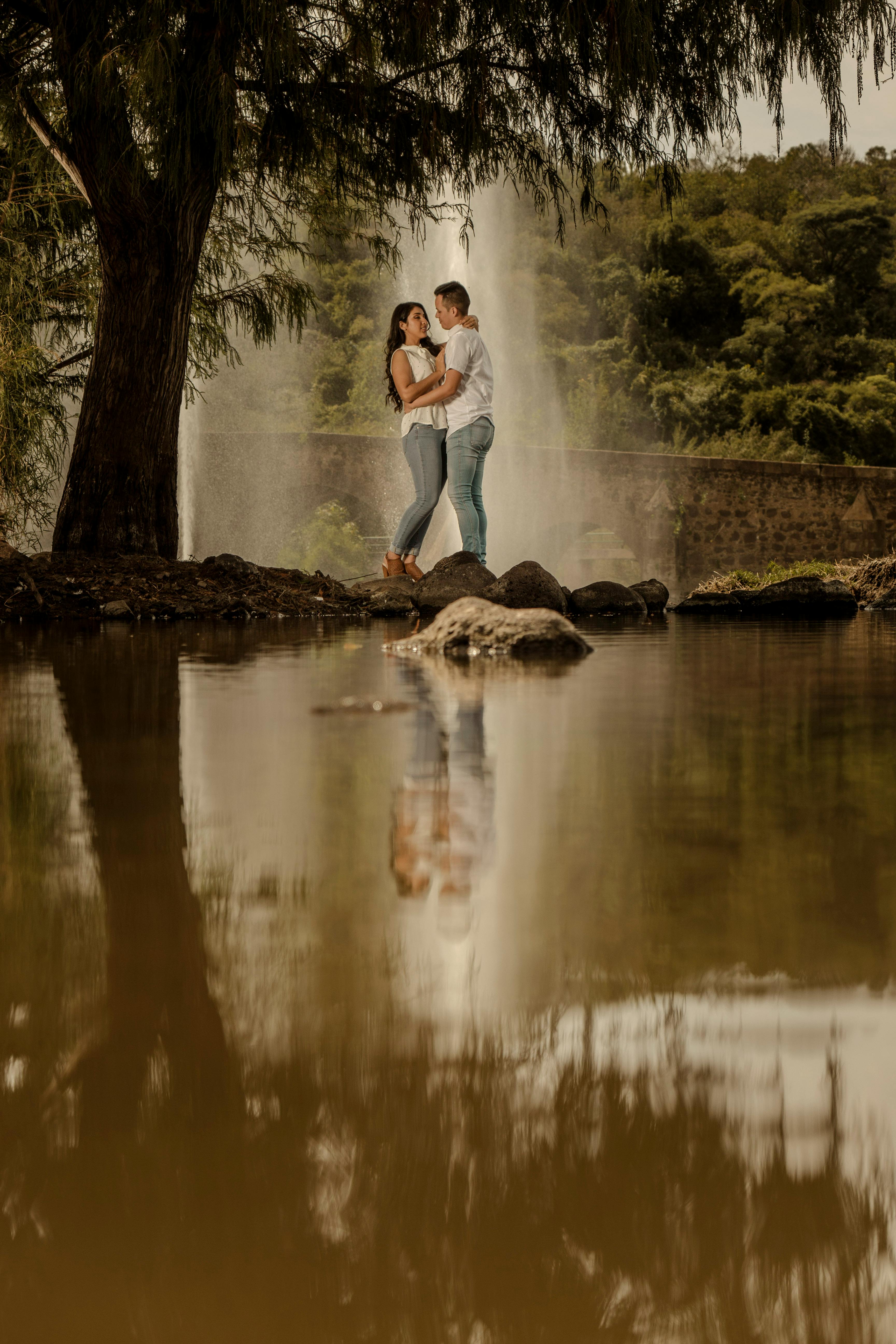 Embracing Couple Standing at the River · Free Stock Photo
