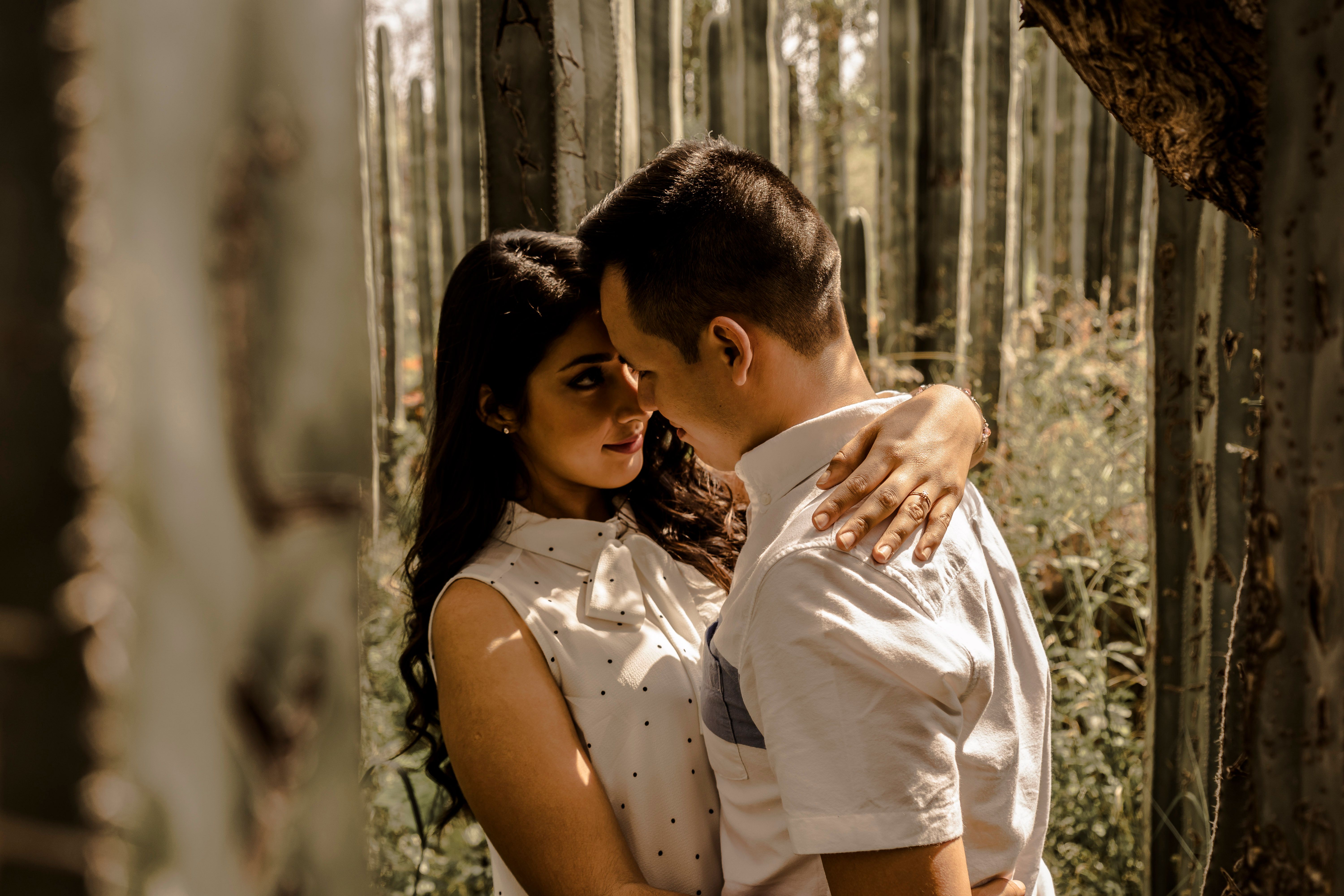Embracing Couple Standing in the Forest · Free Stock Photo