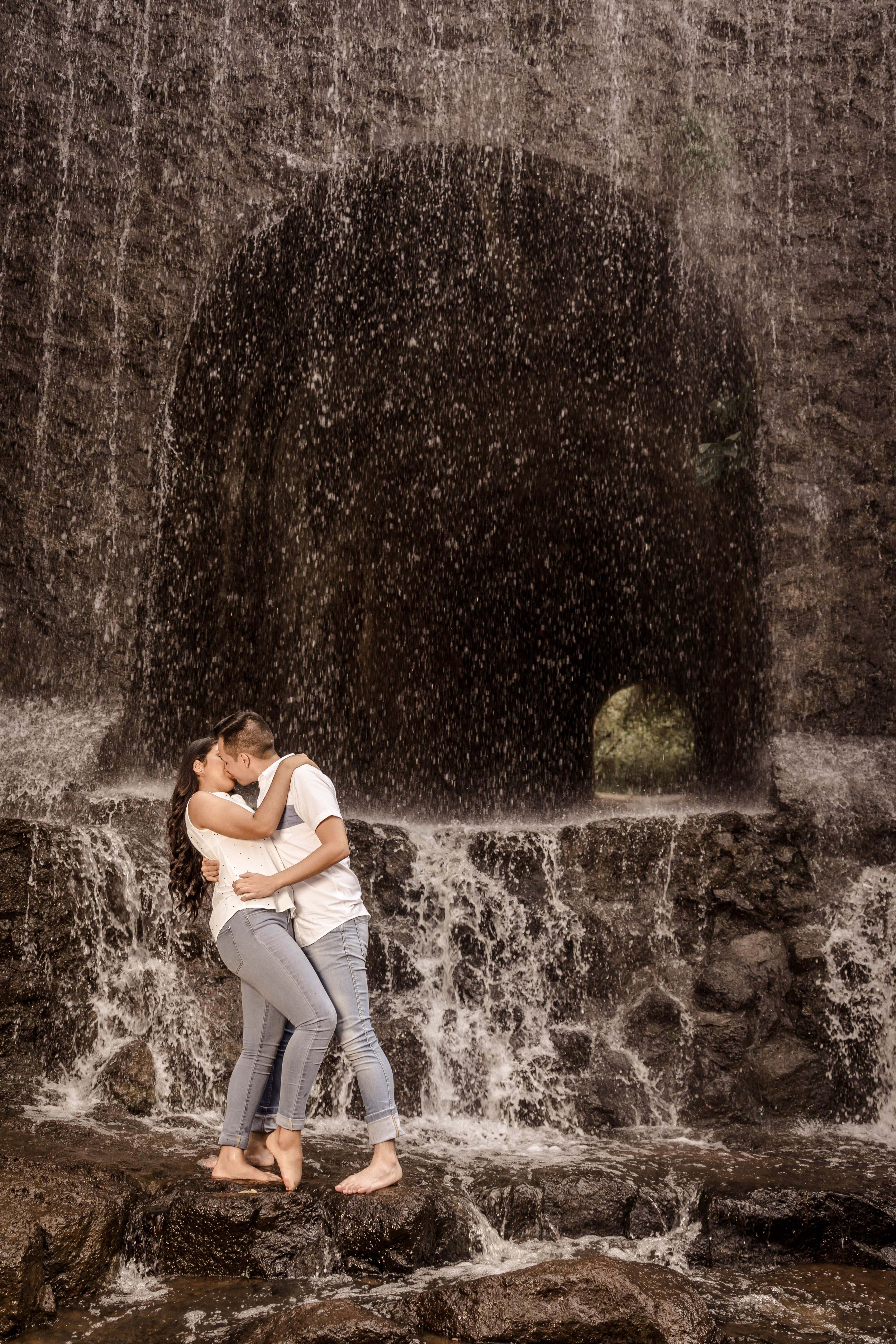 A Couple Kissing under a Waterfall · Free Stock Photo