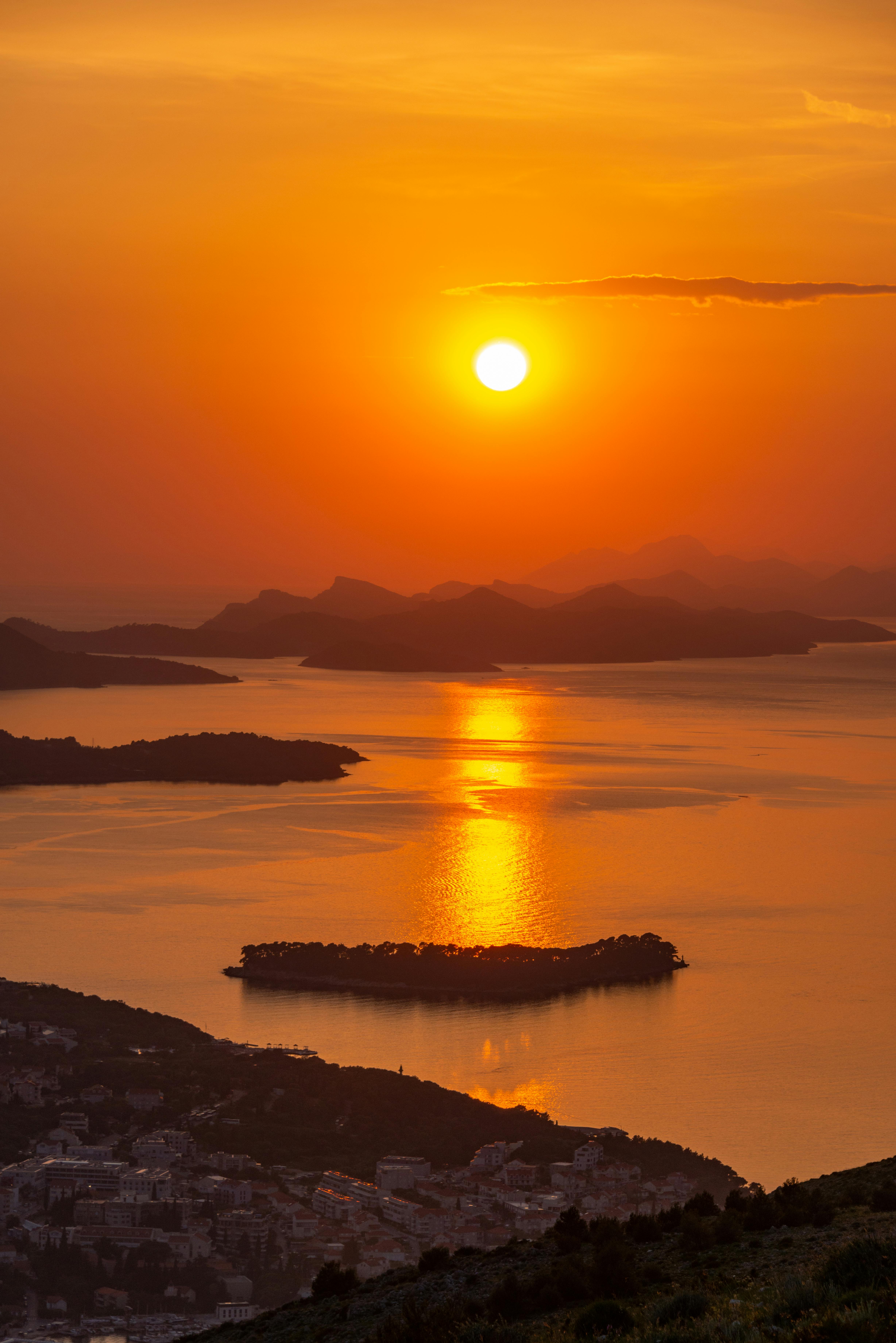 Sun on Yellow Sky over Sea Shore with Islands · Free Stock Photo