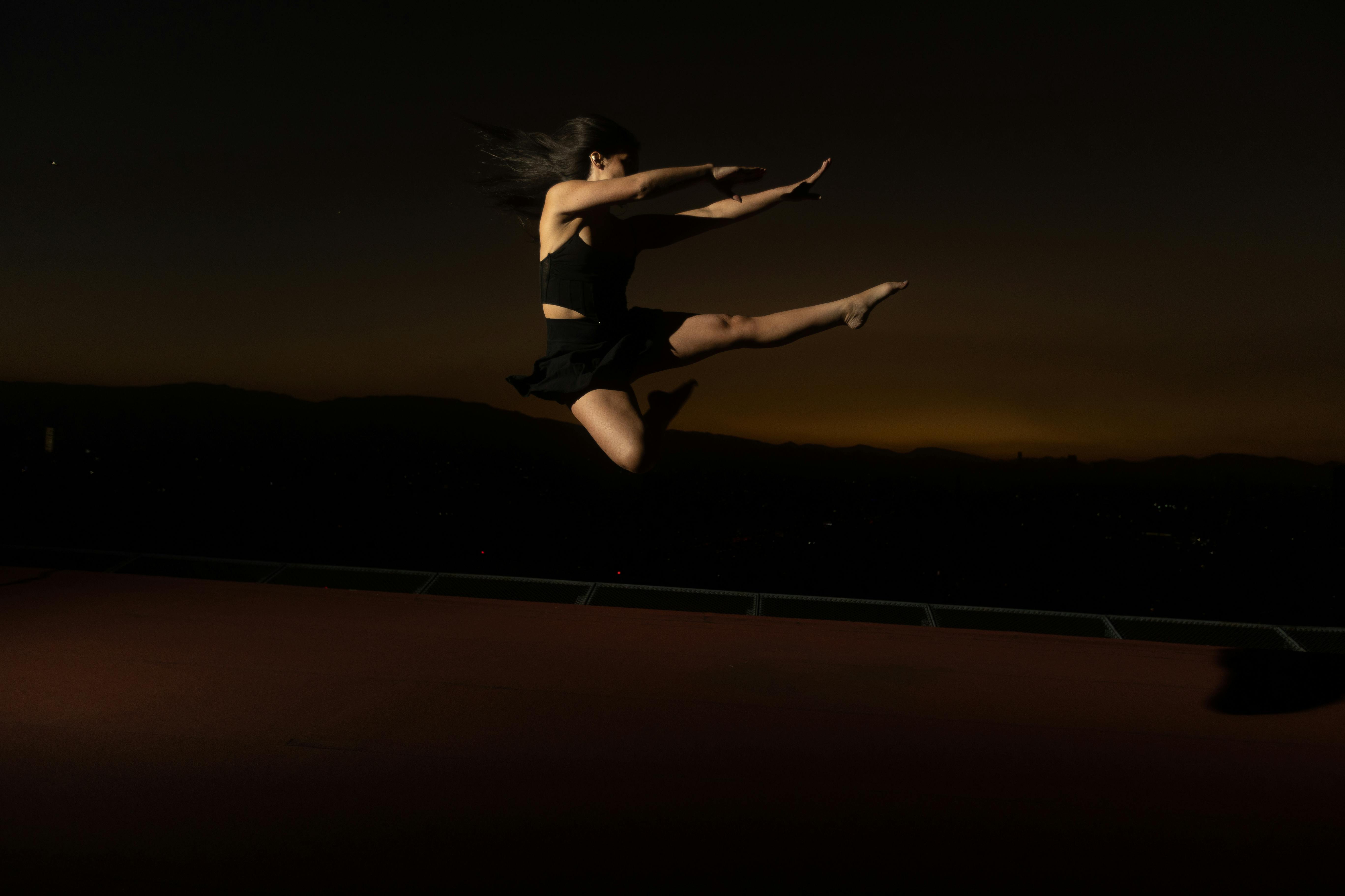 Silhouette of Woman Jumping on Beach during Sunset · Free Stock Photo