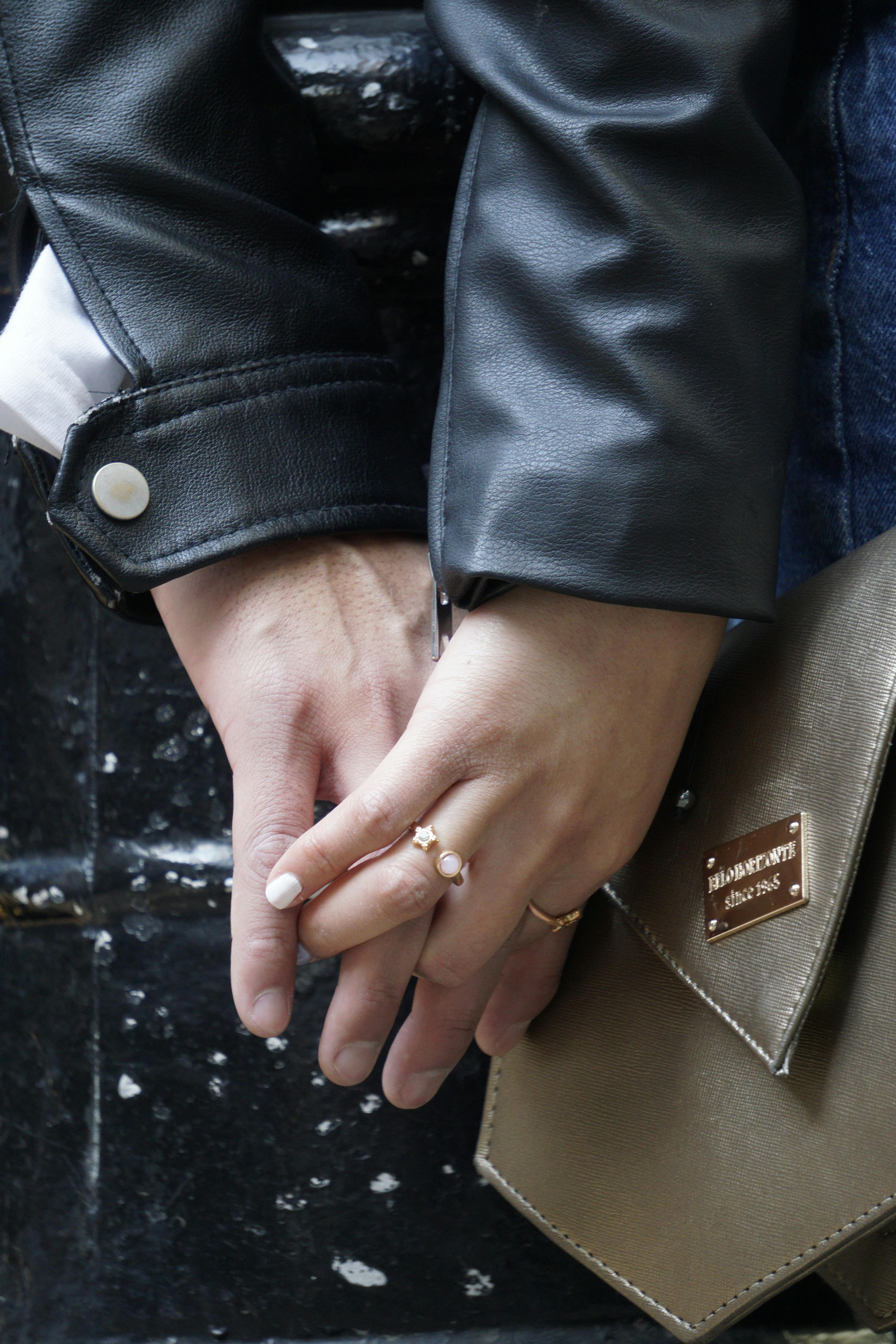 Hands in Leather Sleeves Touching · Free Stock Photo