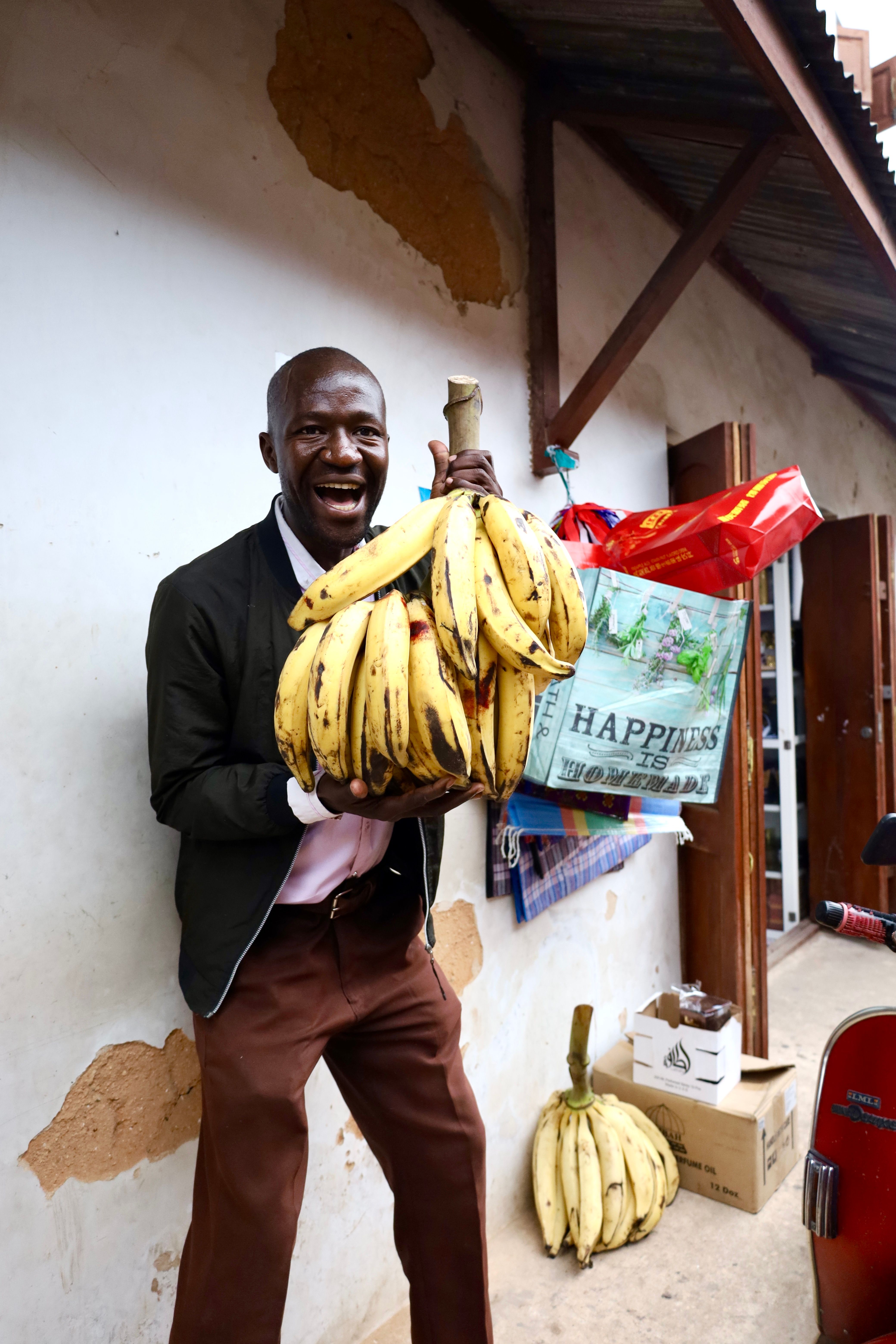 Smiling Man with Bananas · Free Stock Photo
