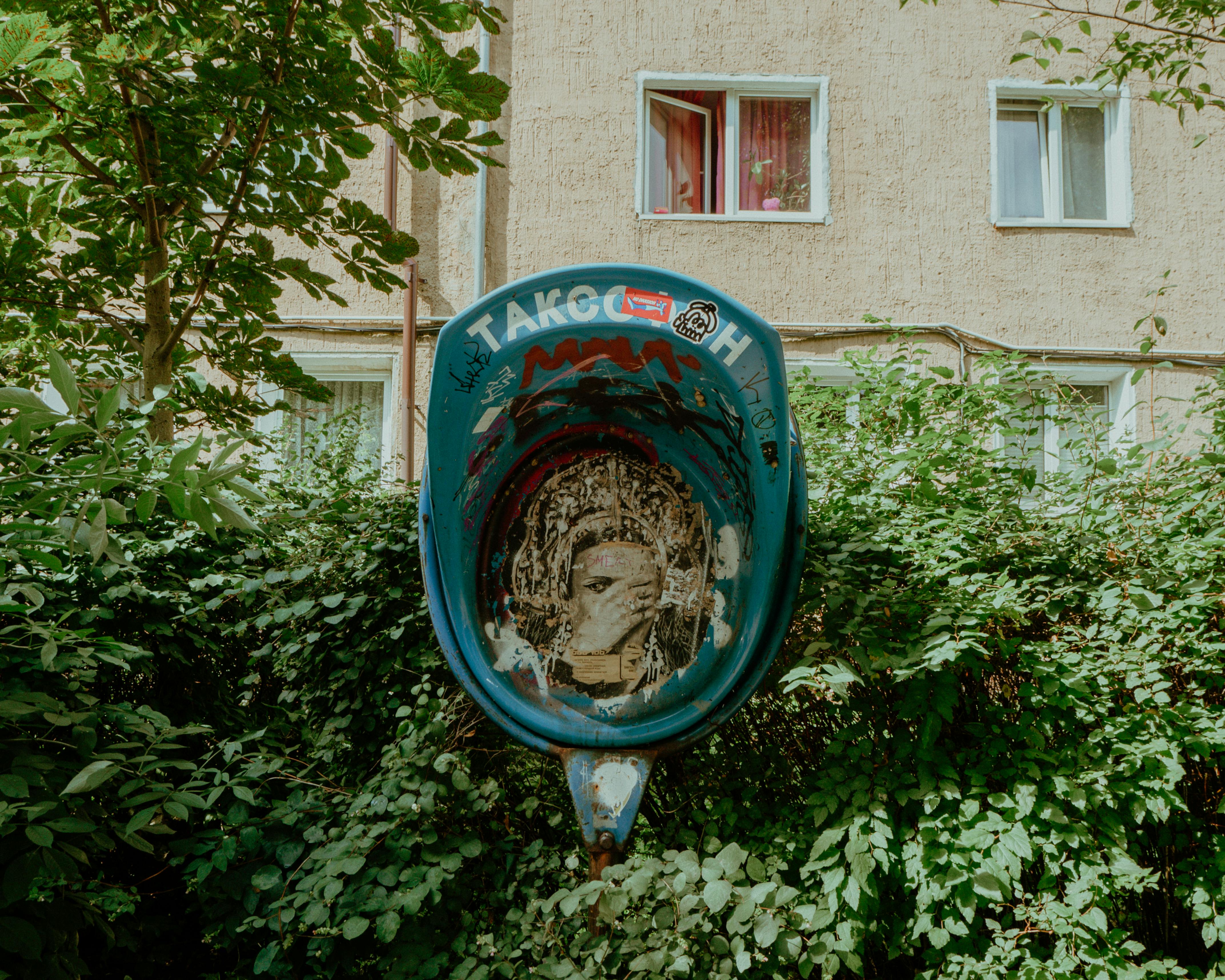 Graffiti on an Abandoned Sign in front of a Residential Building in ...
